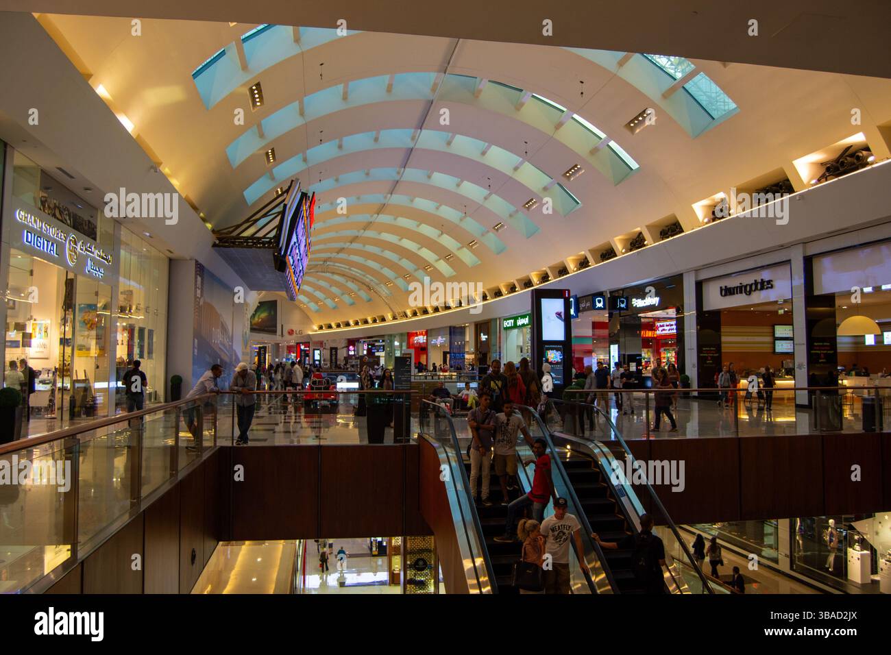 A bustling shopping mall interior featuring a modern architectural ...