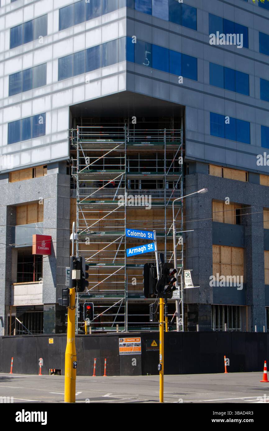 A construction site featuring scaffolding around a modern building. The ...