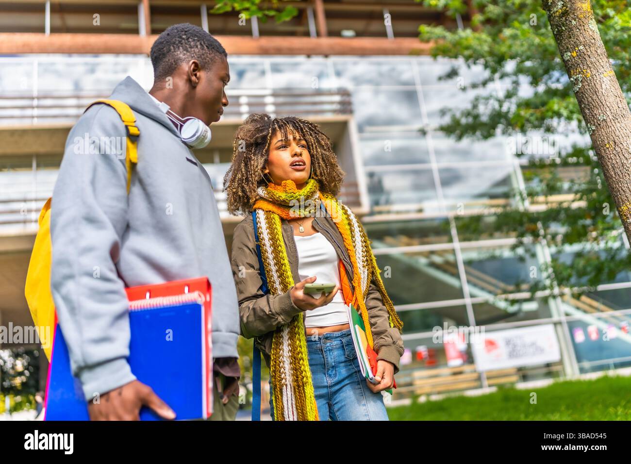 Low angle view photo of two male and female multiethnic students ...