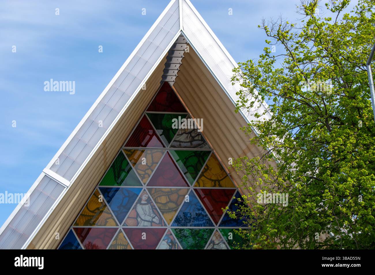 A close-up view of a modern building featuring a colorful stained glass ...