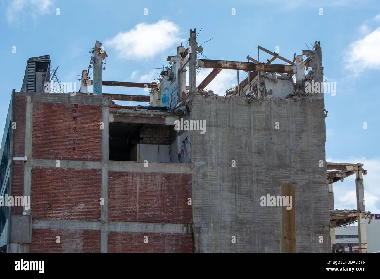 A partially demolished building with exposed concrete and brick walls ...