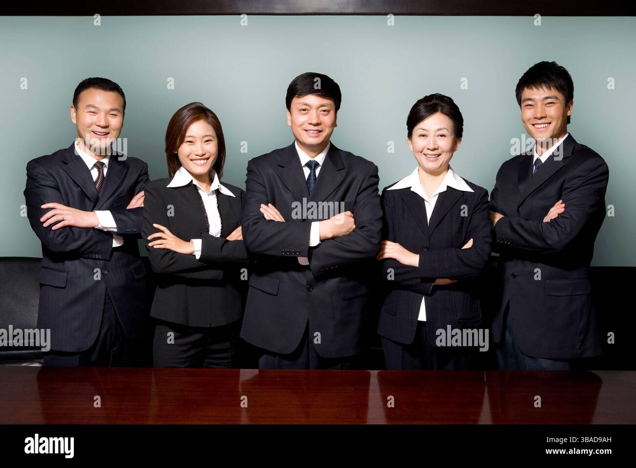 Five Chinese business professionals with arms crossed Stock Photo - Alamy