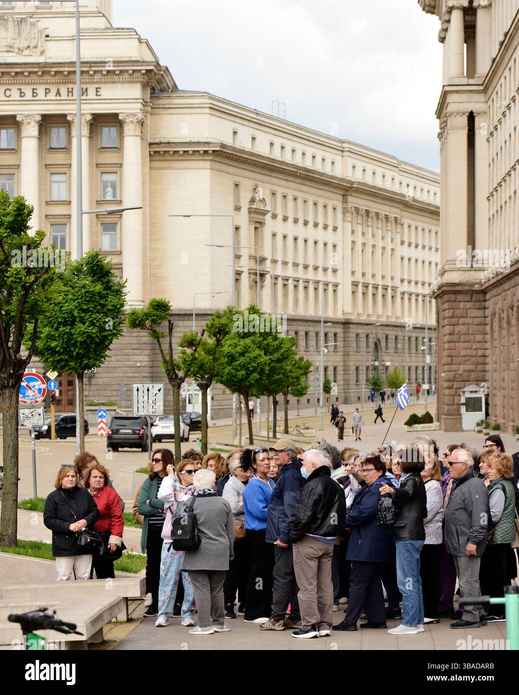 Group of tourists on a guided sightseeing tour at Nezavisimost Square in Sofia Bulgaria, near ...