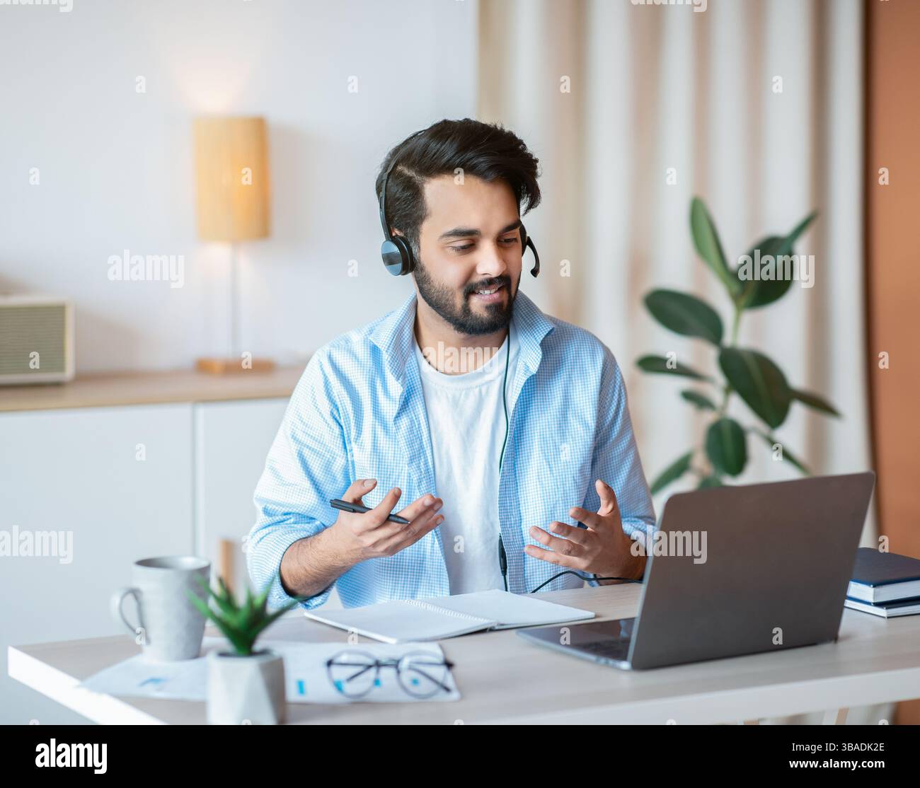 Online Tutoring. Young arab male tutor in headset having video call ...