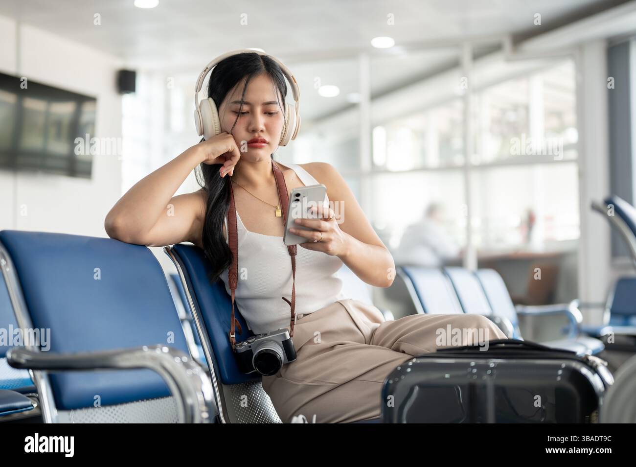 A beautiful Asian female passenger is feeling tired and bored while ...