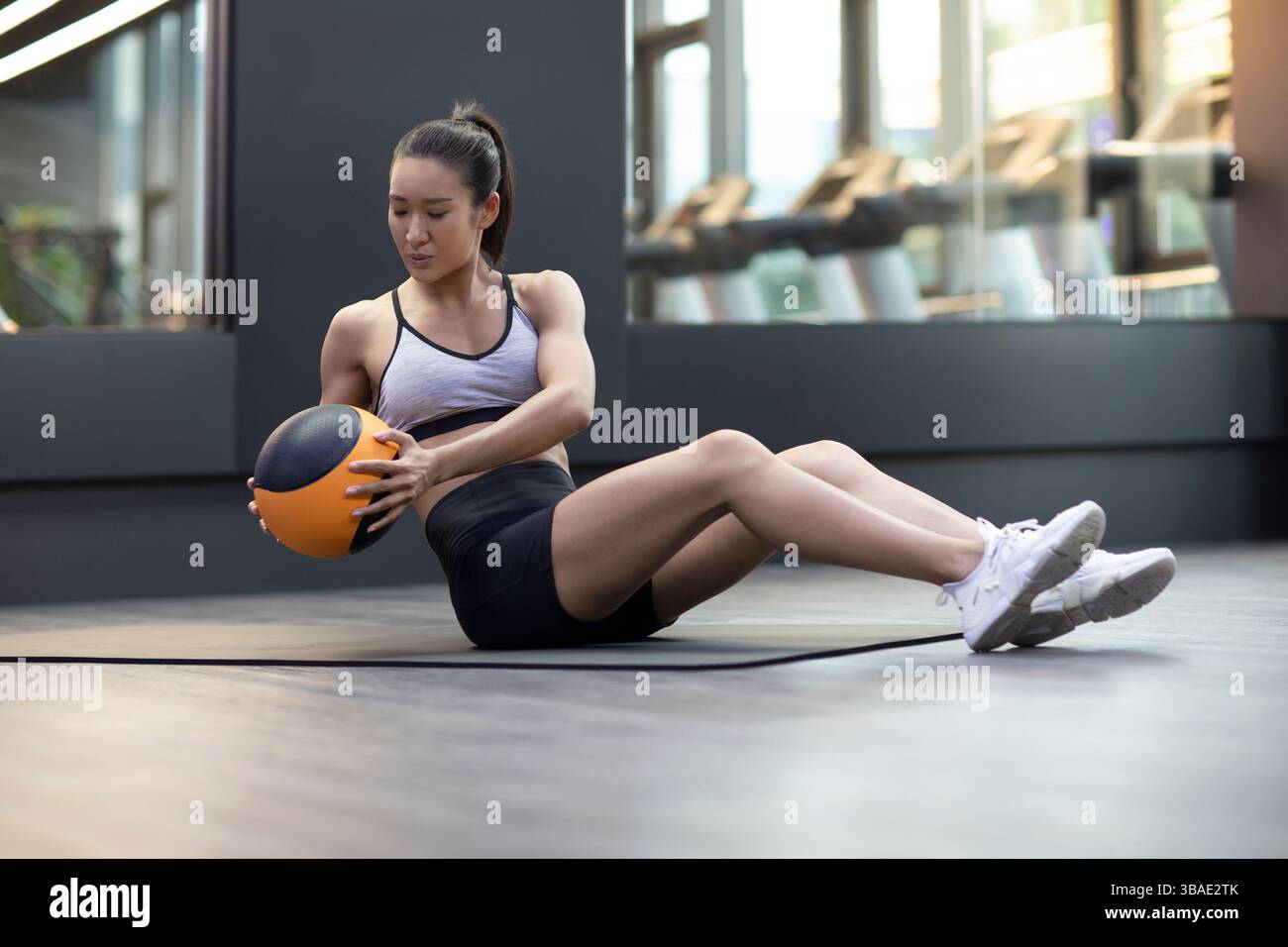 Young Chinese woman exercising at gym Stock Photo - Alamy