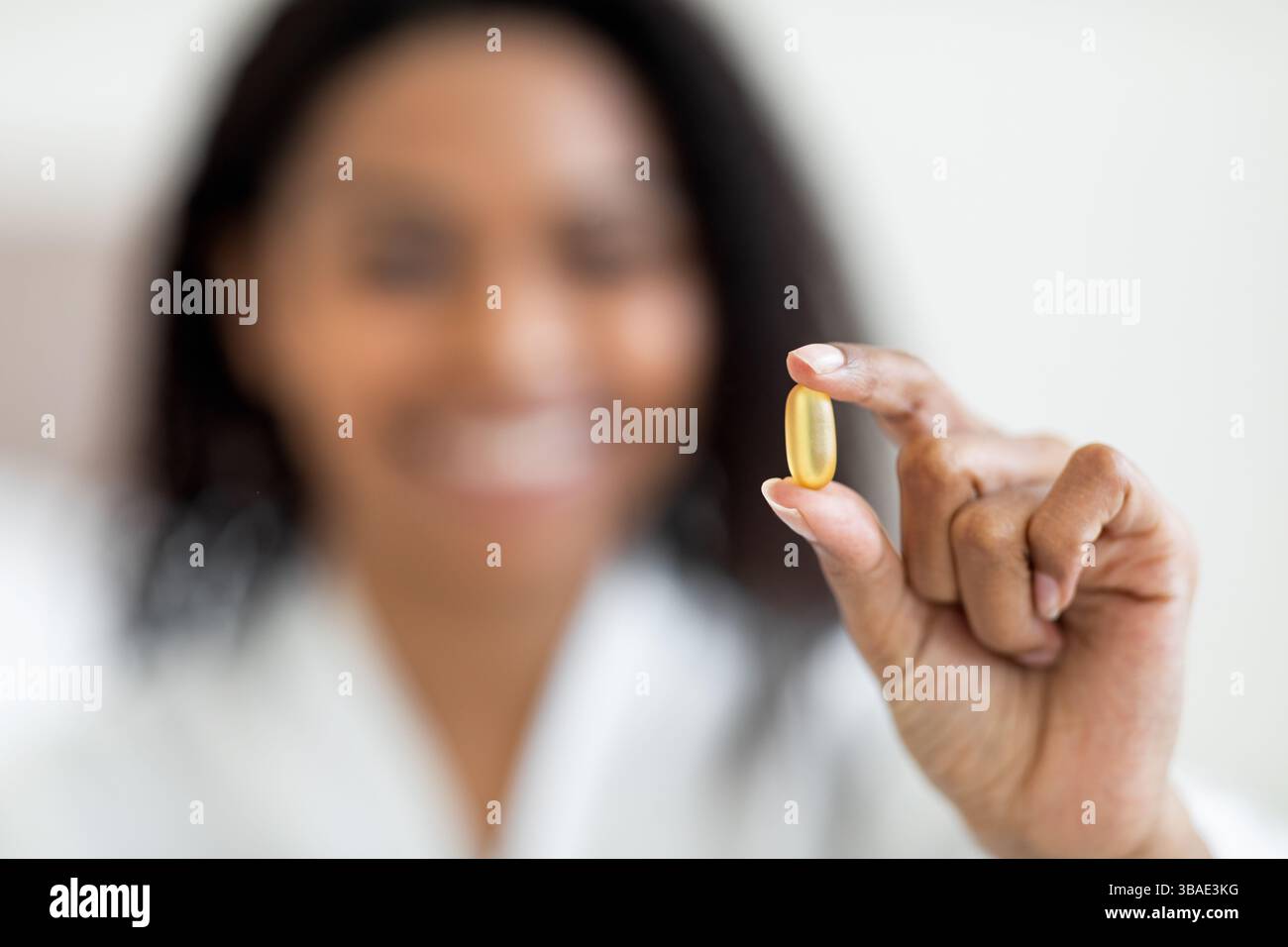 Beauty Supplement. Transparent Vitamin Pill In Hand Of Smiling Black ...