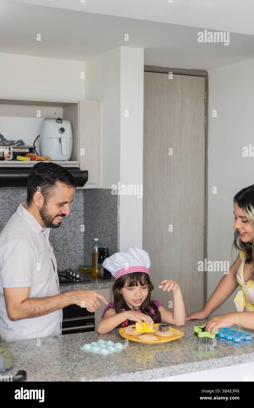 Happy family baking cookies together in the kitchen, having fun and ...