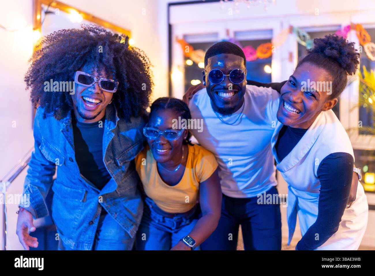 Portrait of a multiracial group of friends embracing from back enjoying ...