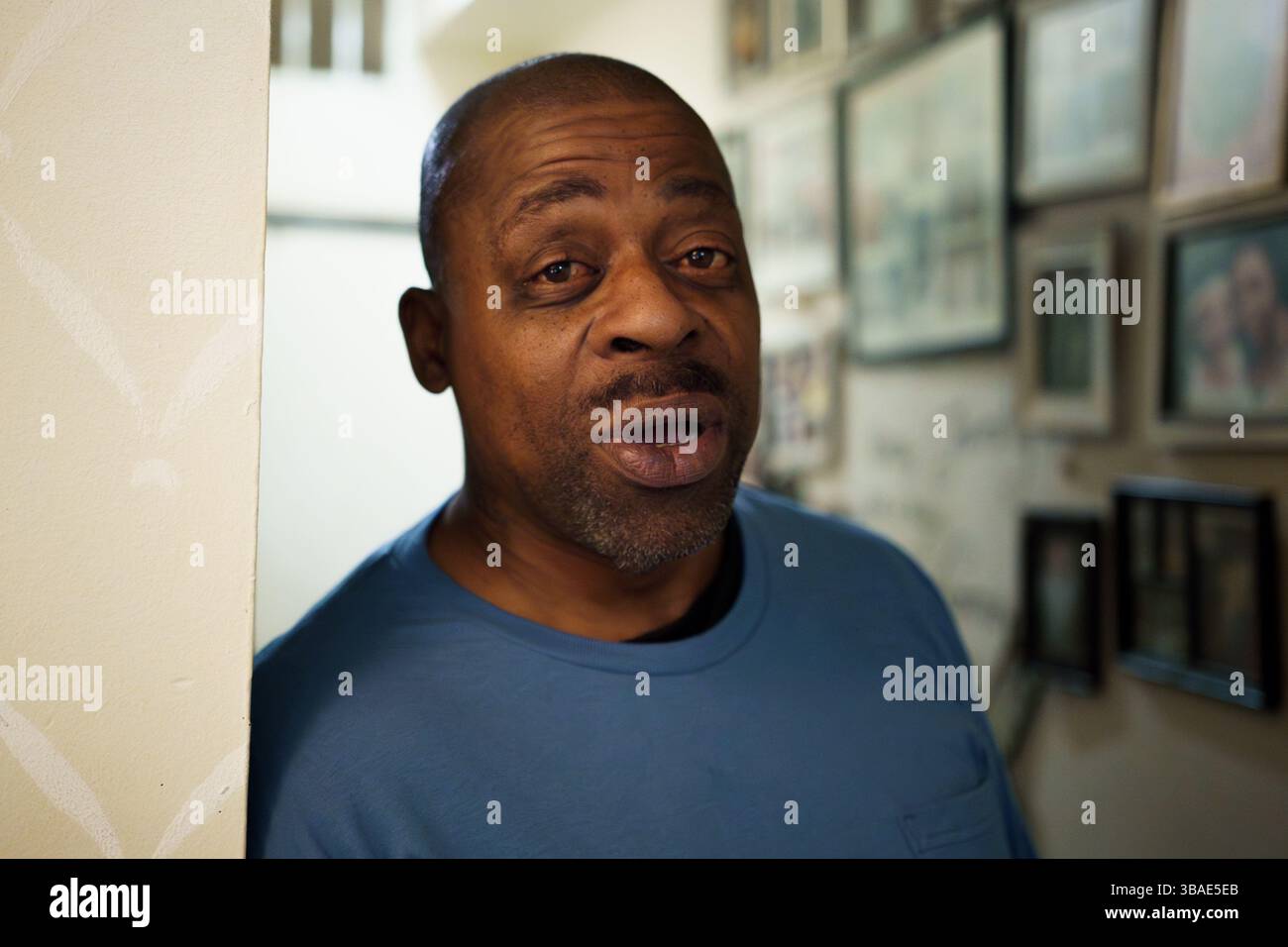 Black man pouting looking to the side while standing and talking at ...