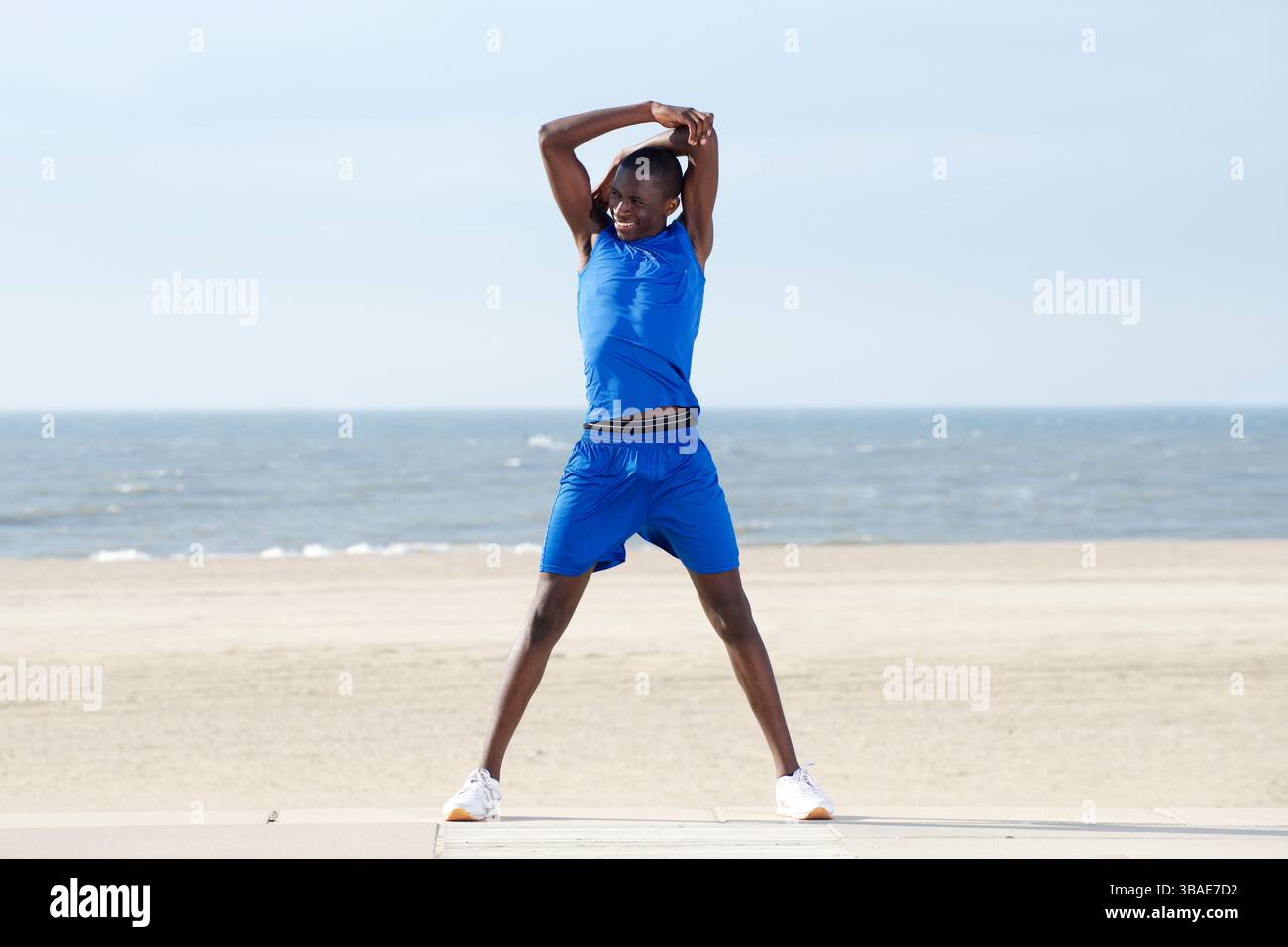 Full length portrait of fit young african american man stretching arms ...