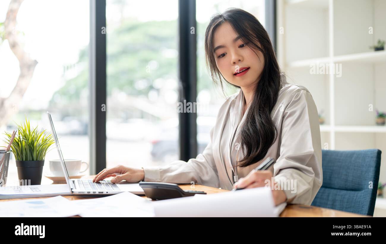 An attractive and professional Asian businesswoman or female manager is ...