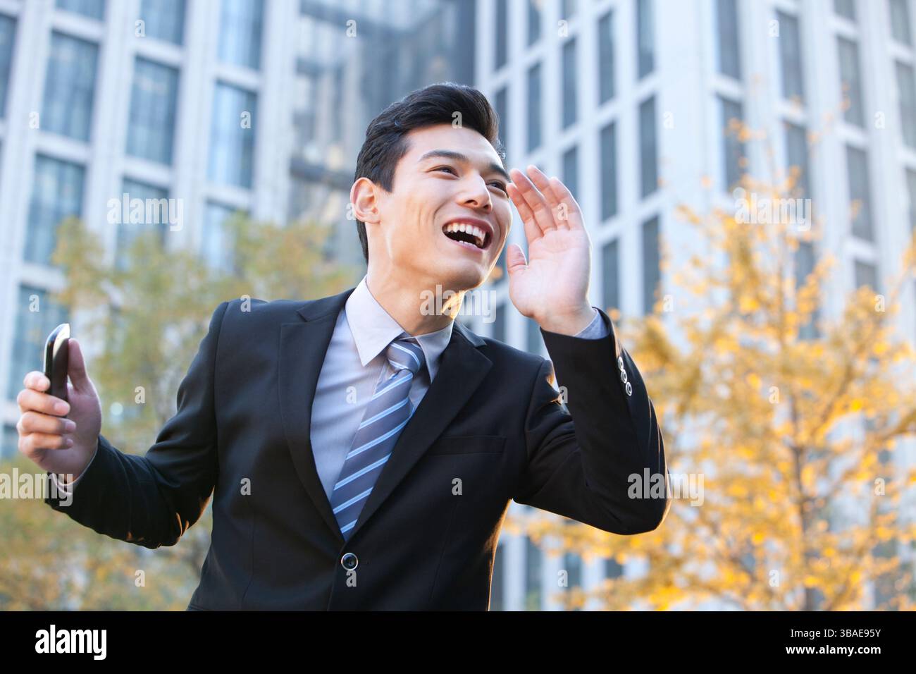 Chinese businessman calling people outside Stock Photo - Alamy