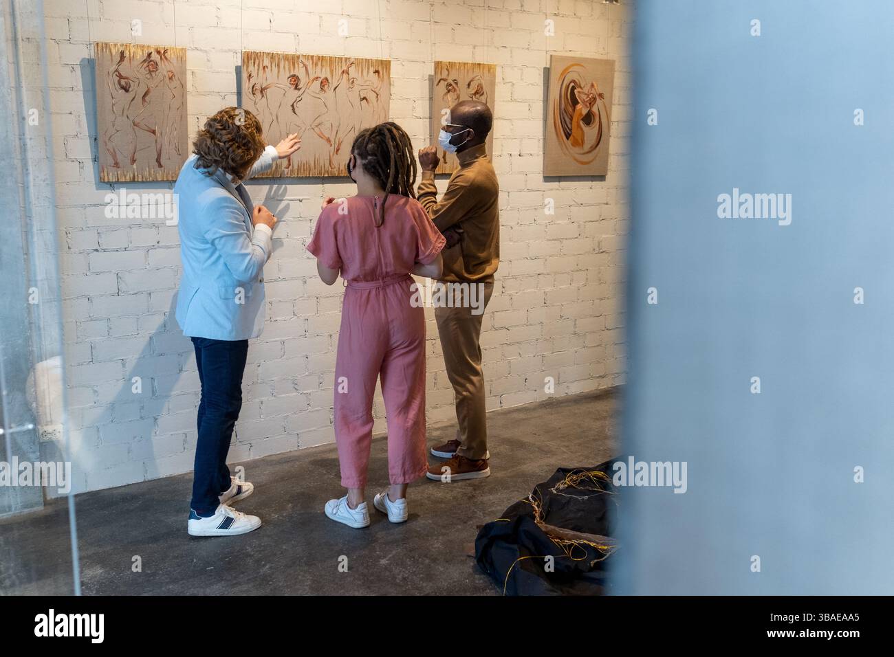 Serious Diverse Group listening to artist during presentation of his ...