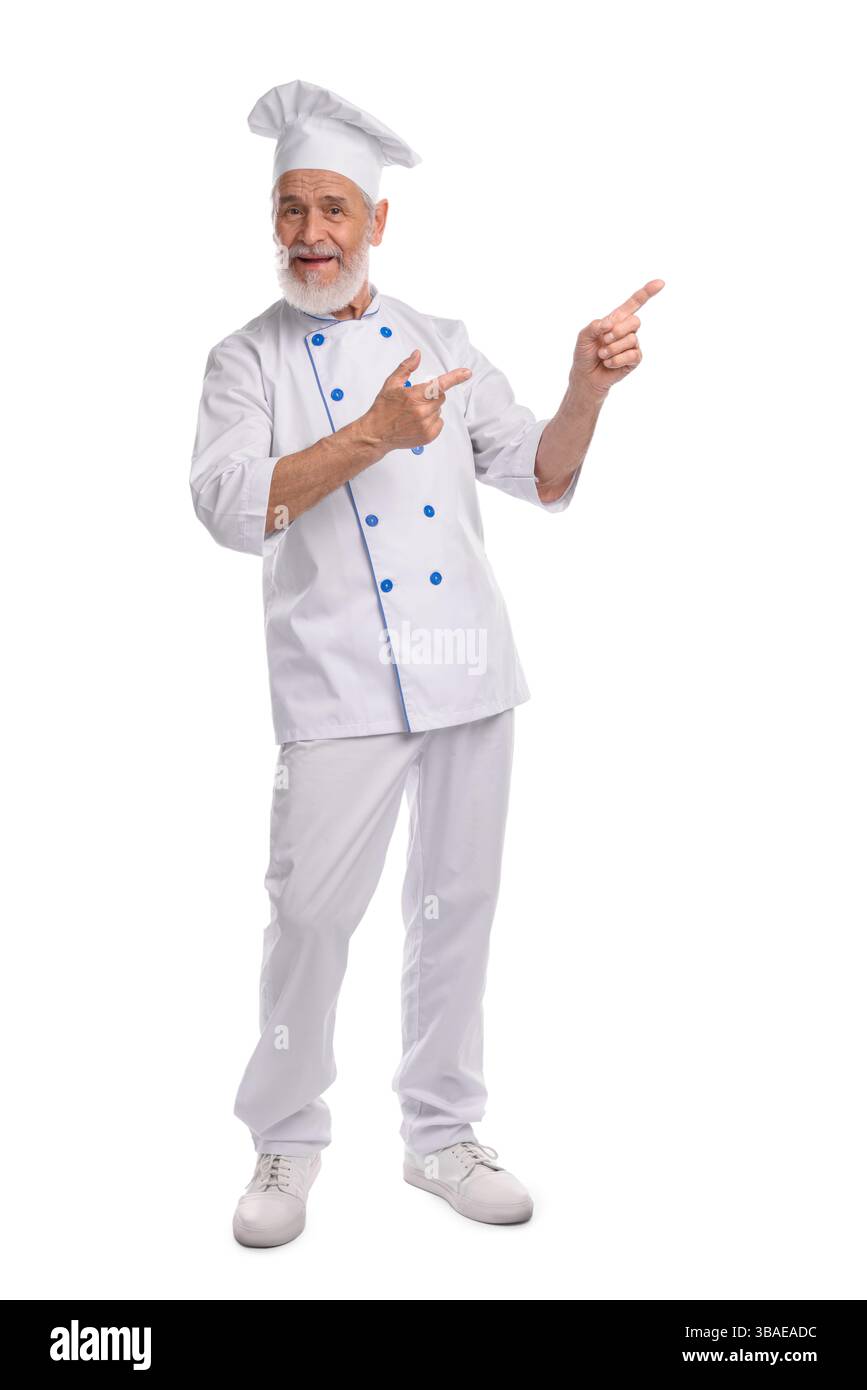 Professional pastry chef pointing at something on white background ...