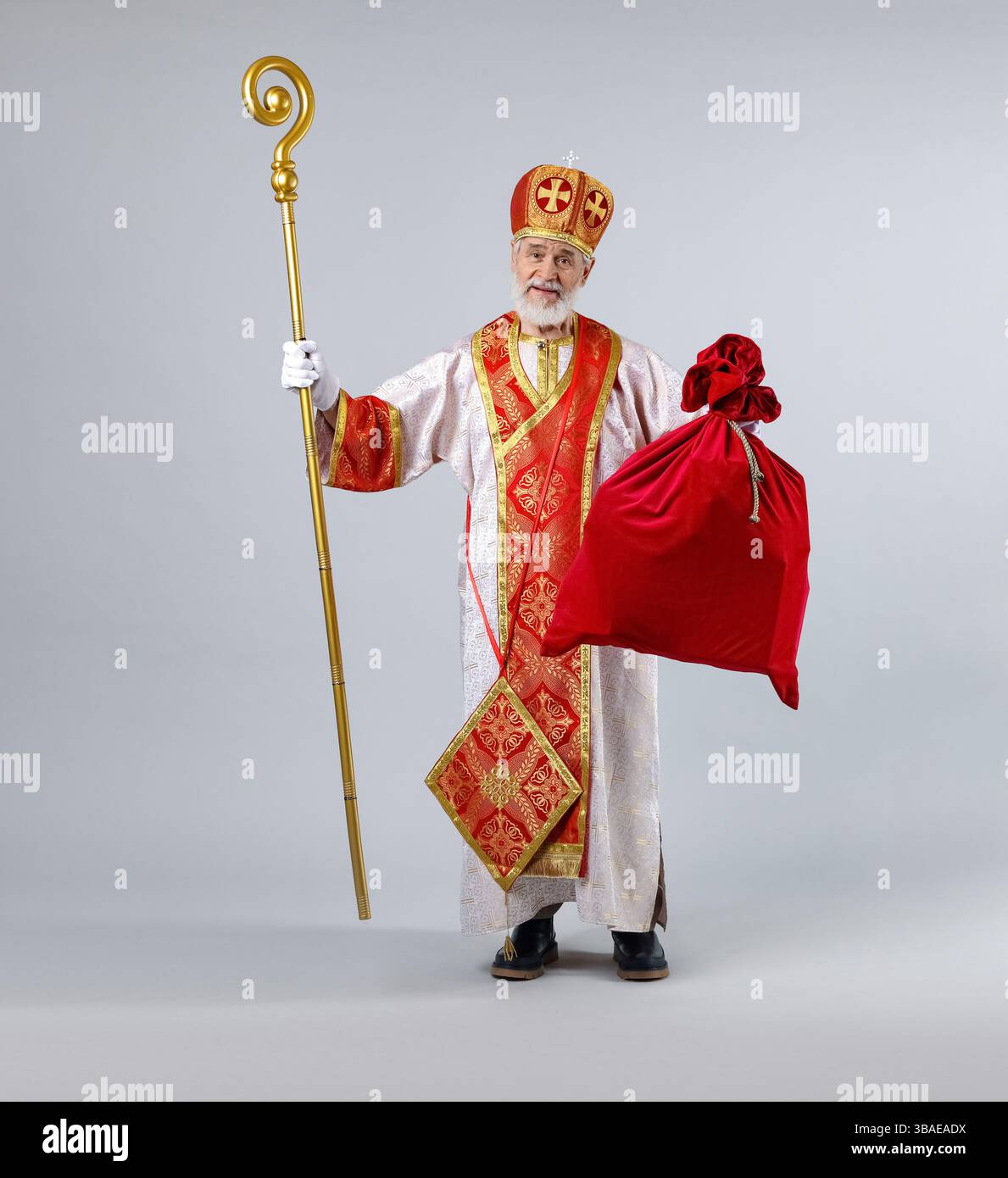Saint Nicholas with sack on light grey background Stock Photo - Alamy