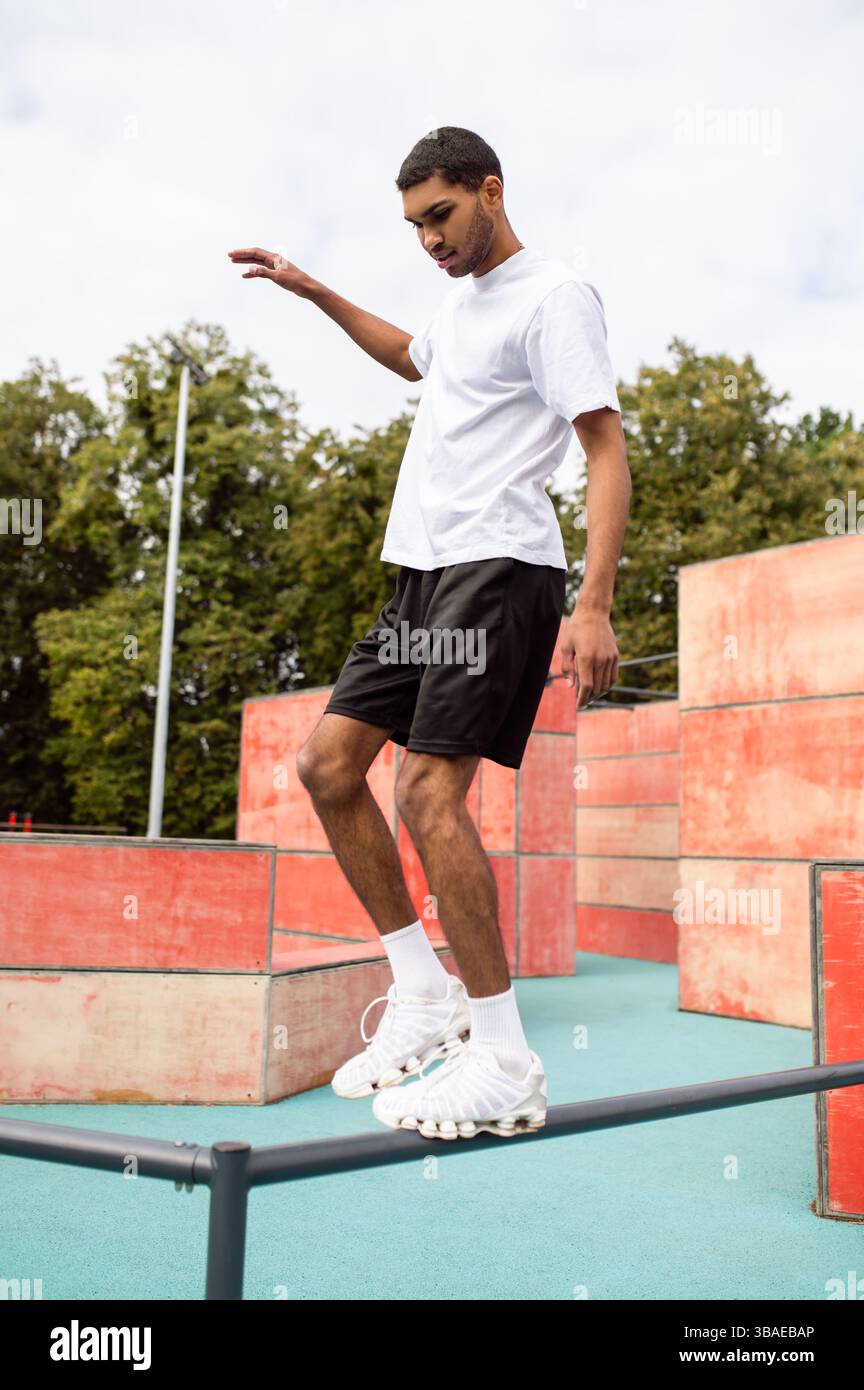 Balance. Young man keeping balance and looking concentrated Stock Photo ...