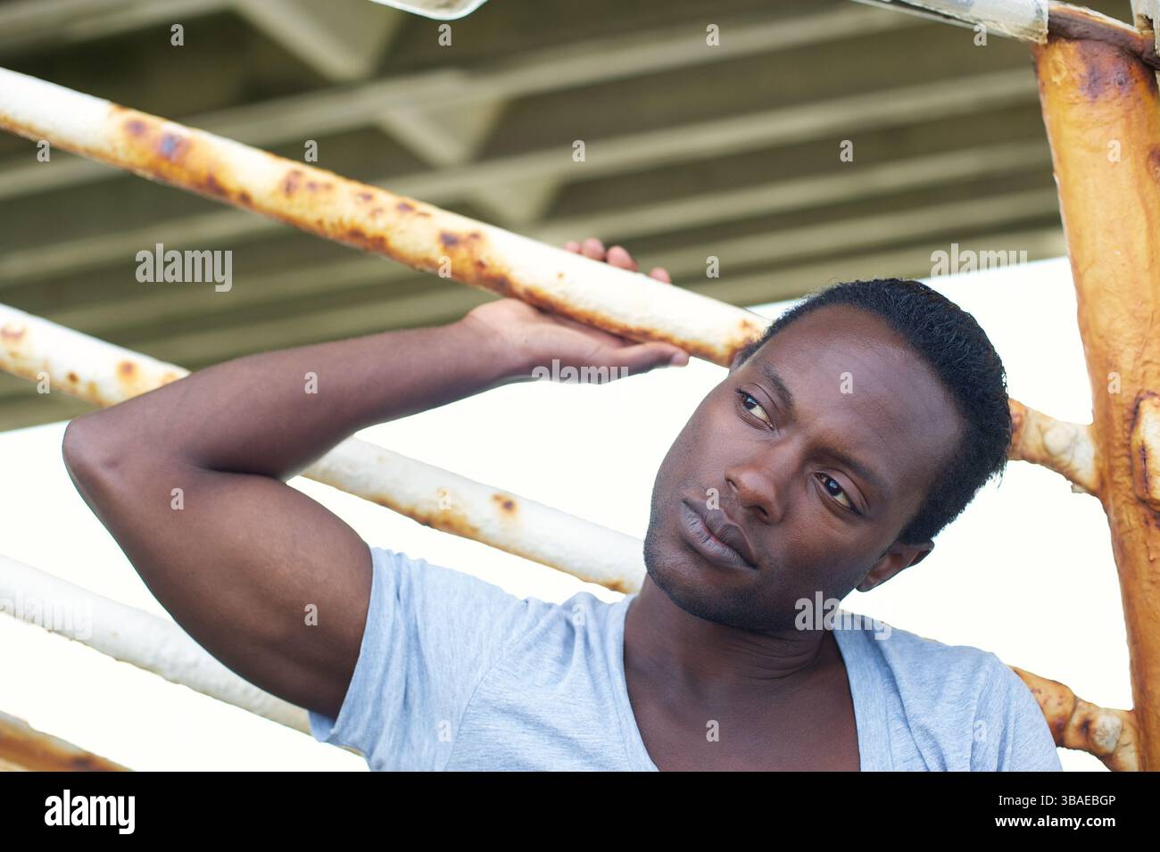 Horizontal portrait of a handsome male model sitting outdoors and ...