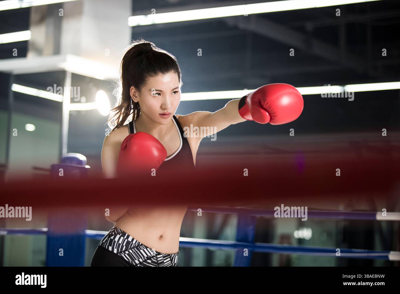 Female Chinese boxer practicing in boxing ring Stock Photo - Alamy