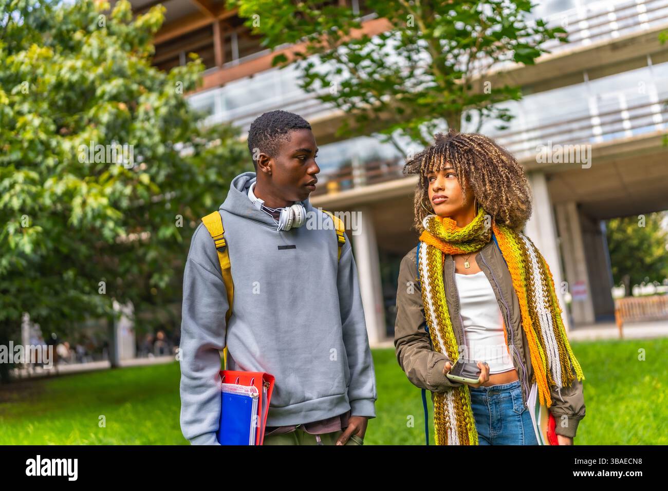 Diverse students back to university walking and talking outside the ...