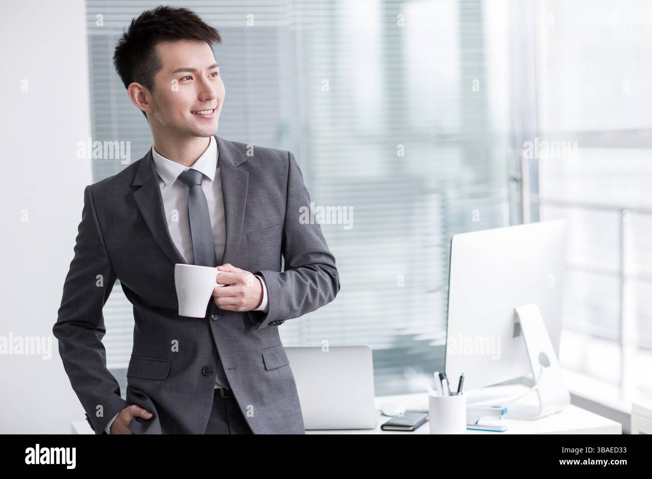 Chinese businessman taking a coffee break Stock Photo - Alamy