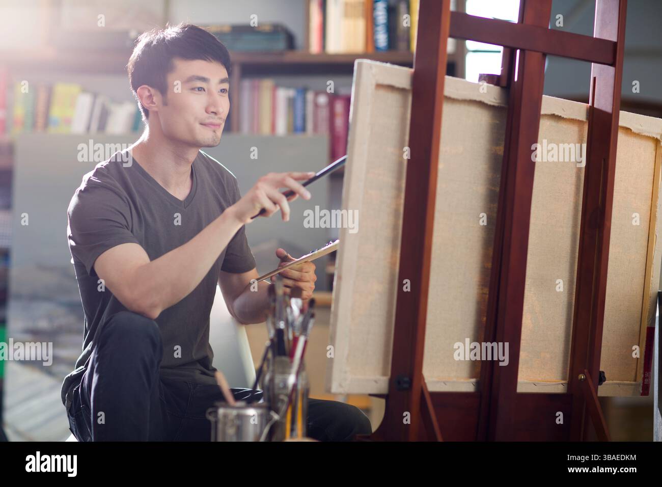 Chinese artist painting in his studio Stock Photo - Alamy