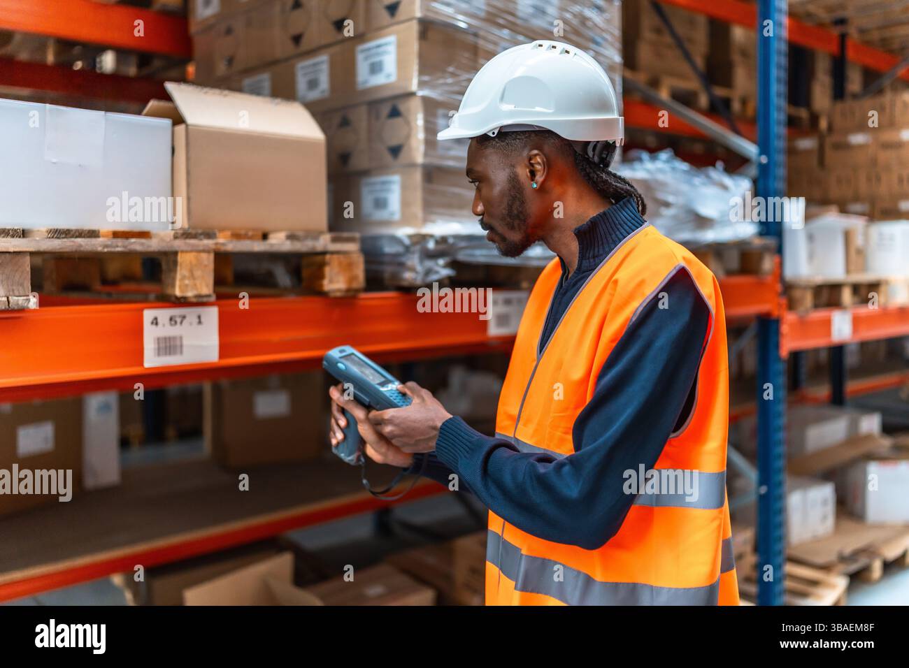 Side view of an african male supervisor in orange reflective waistcoat ...