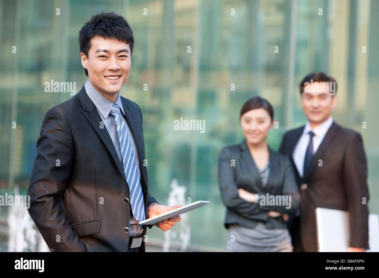 Chinese business people outside office building Stock Photo - Alamy