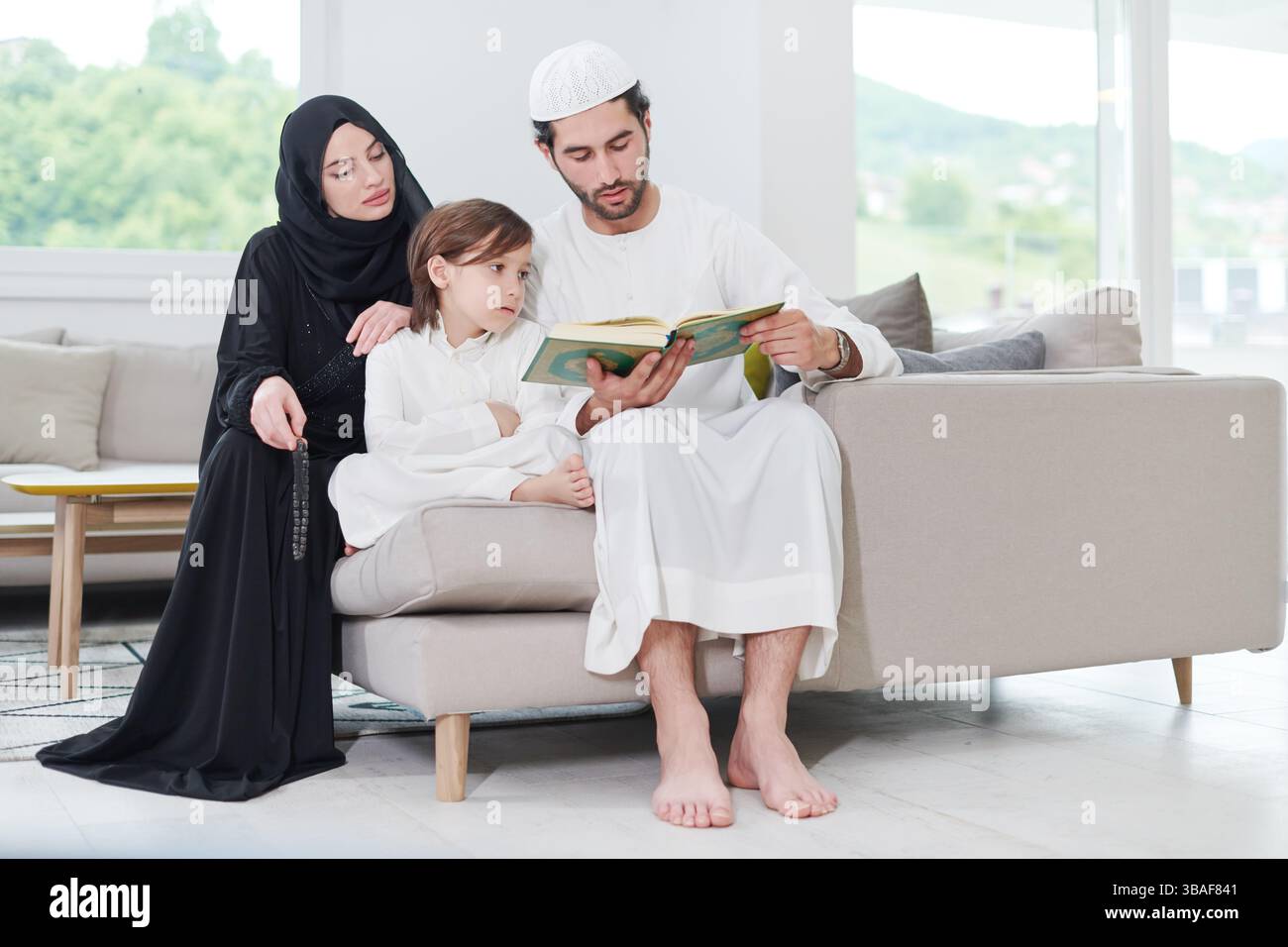 Traditional muslim family parents with children reading Quran and ...