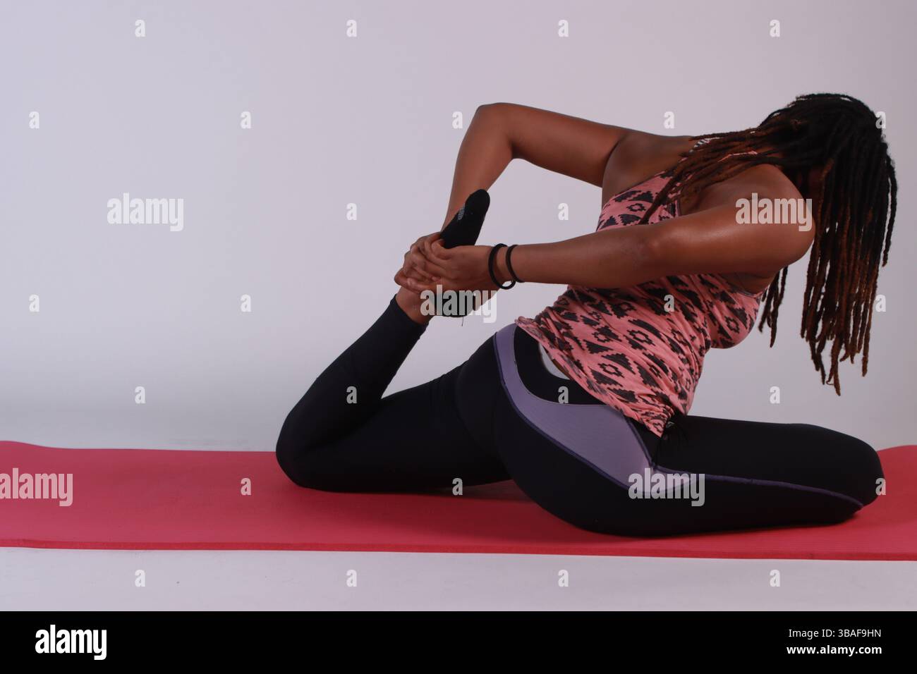 Black Afro-Caribbean woman with natural dreadlocks wearing fitness ...