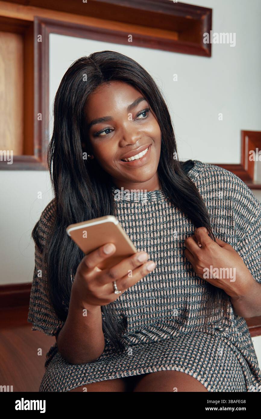 Positive pretty young woman thinking what to answer on text message ...