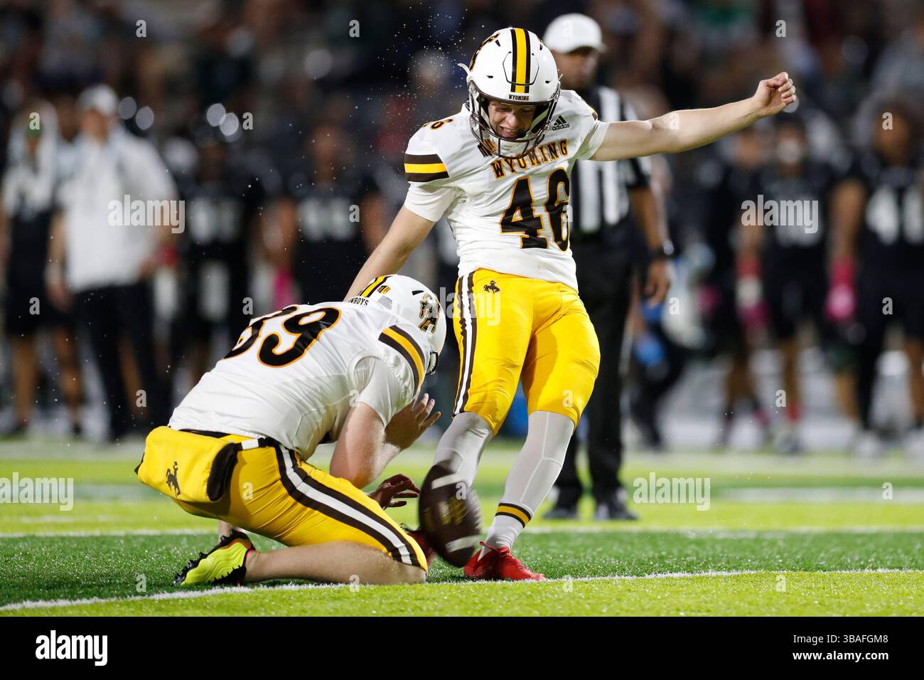 FILE - As Wyoming punter Clayton Stewart (39) holds the ball, place ...