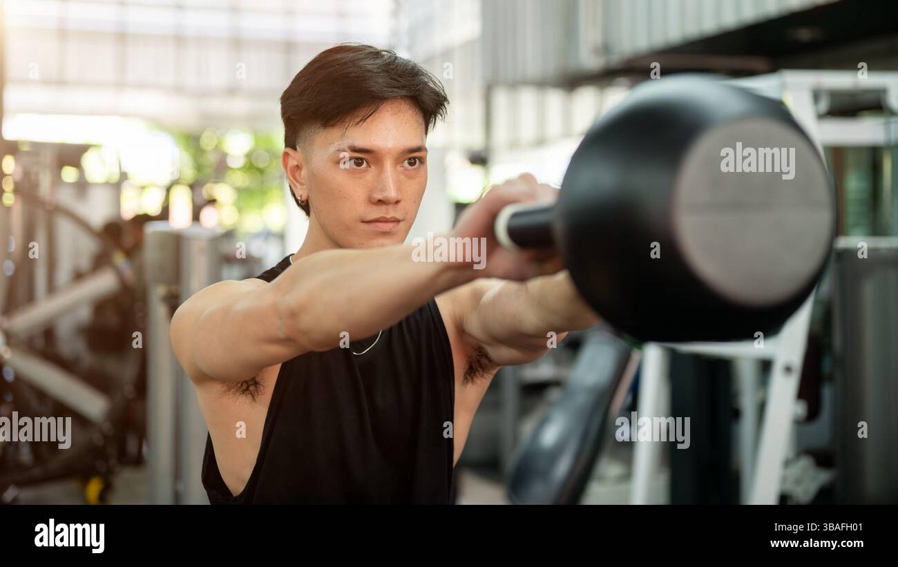 A determined and strong Asian man in sportswear is working out with a ...