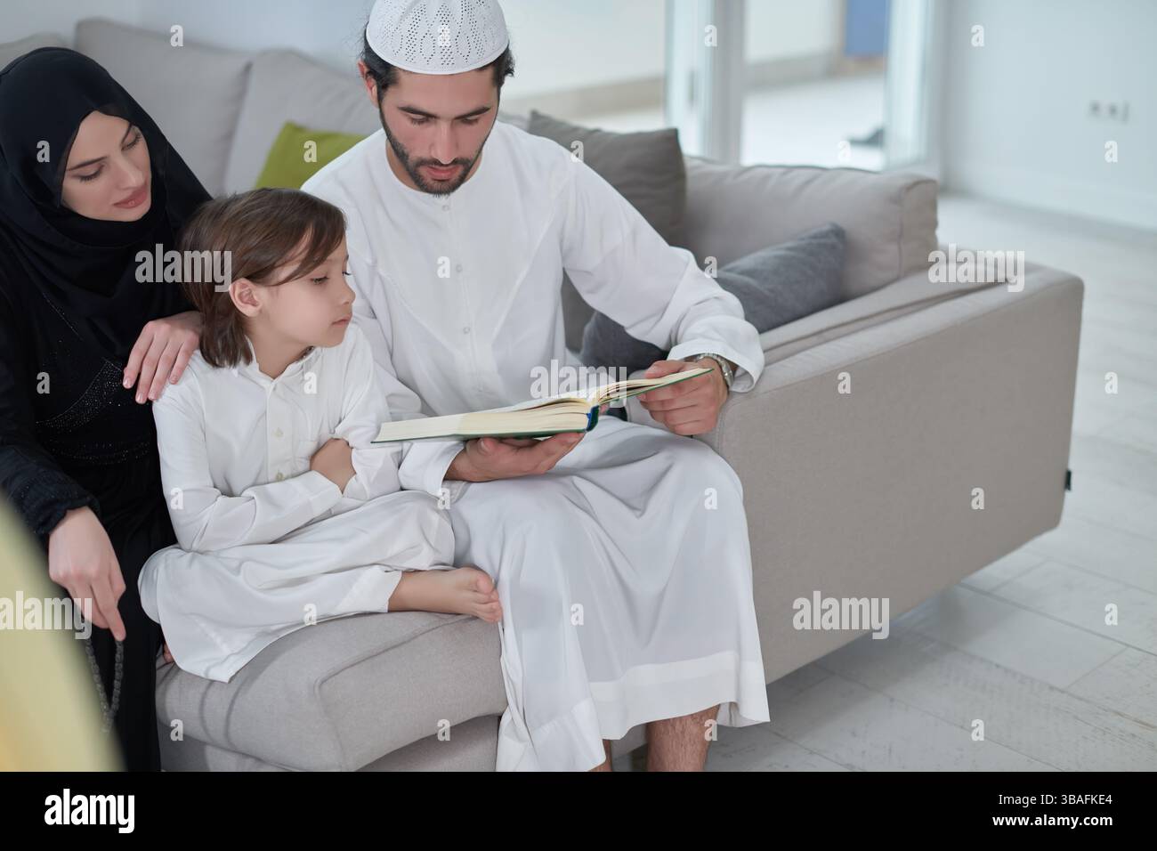 Young muslim family reading Quran during Ramadan. Parents and son ...