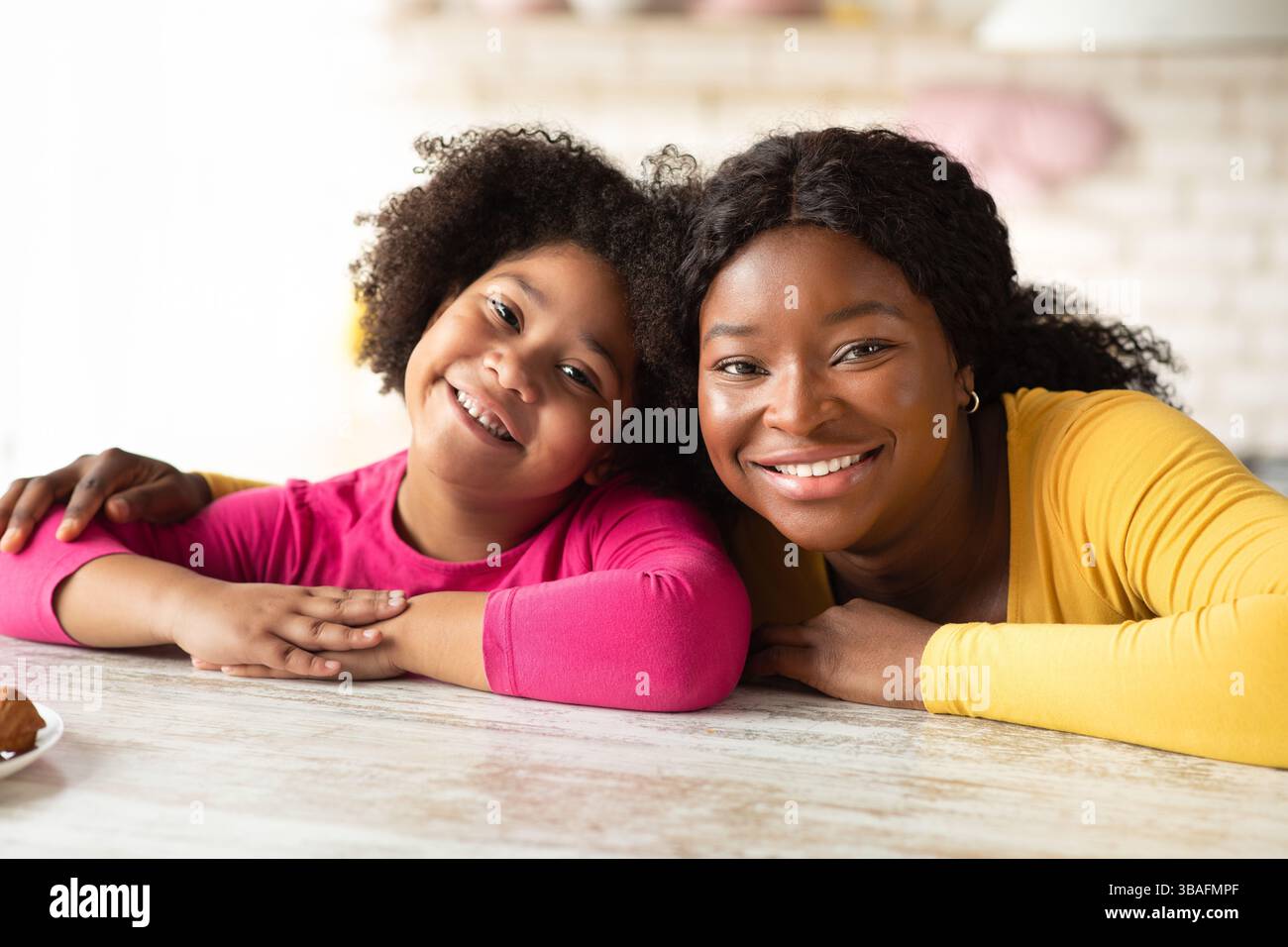 Closeup Portrait Of Happy African American Mother And Her Little Daughter Sitting At Table In ...