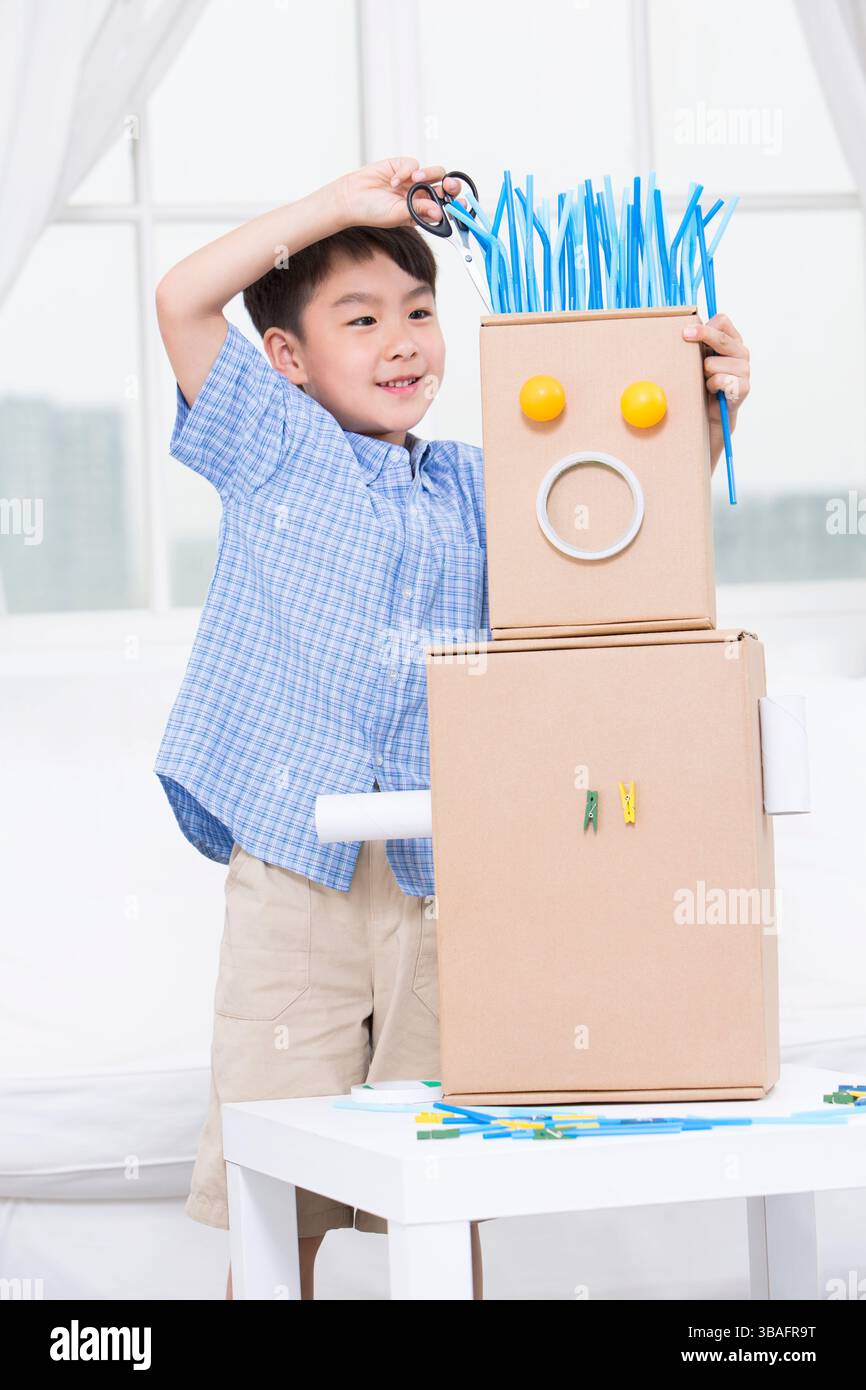 Chinese boy making a toy robot Stock Photo - Alamy