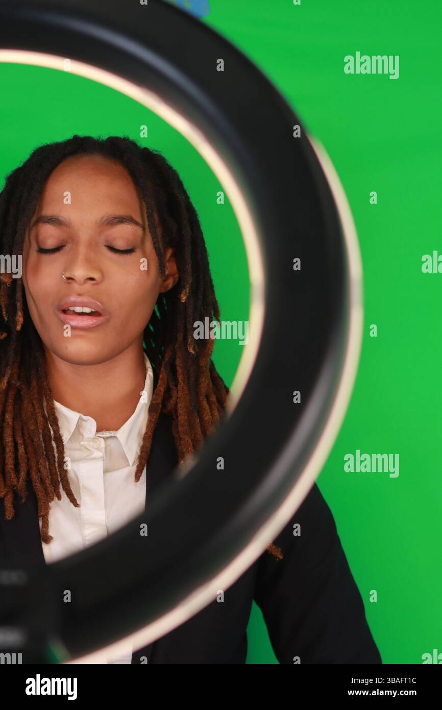Black woman of Afro-Caribbean descent with dreadlocks dressed in formal business attire set ...