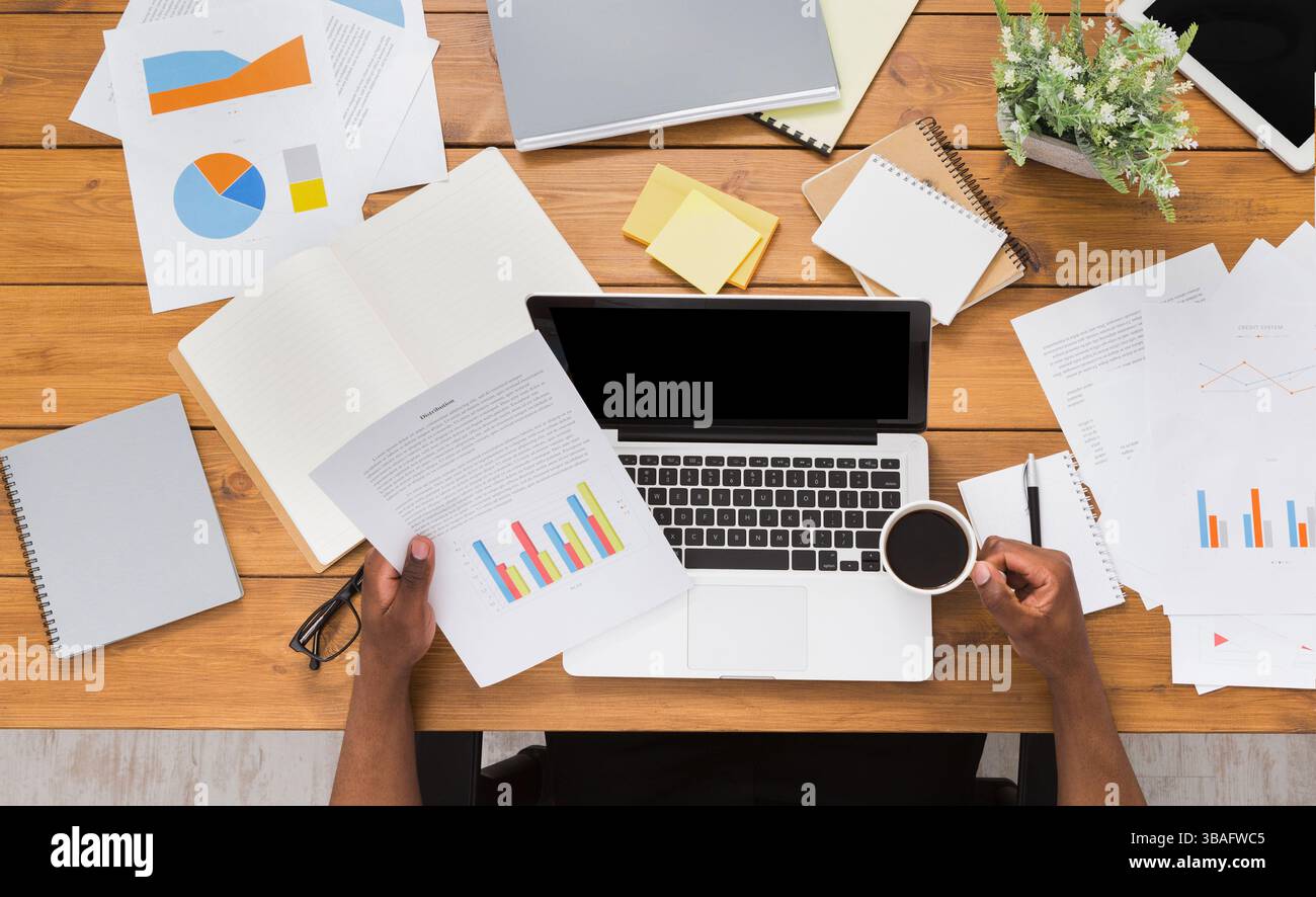 Office workspace top view. African-american businessman working at ...