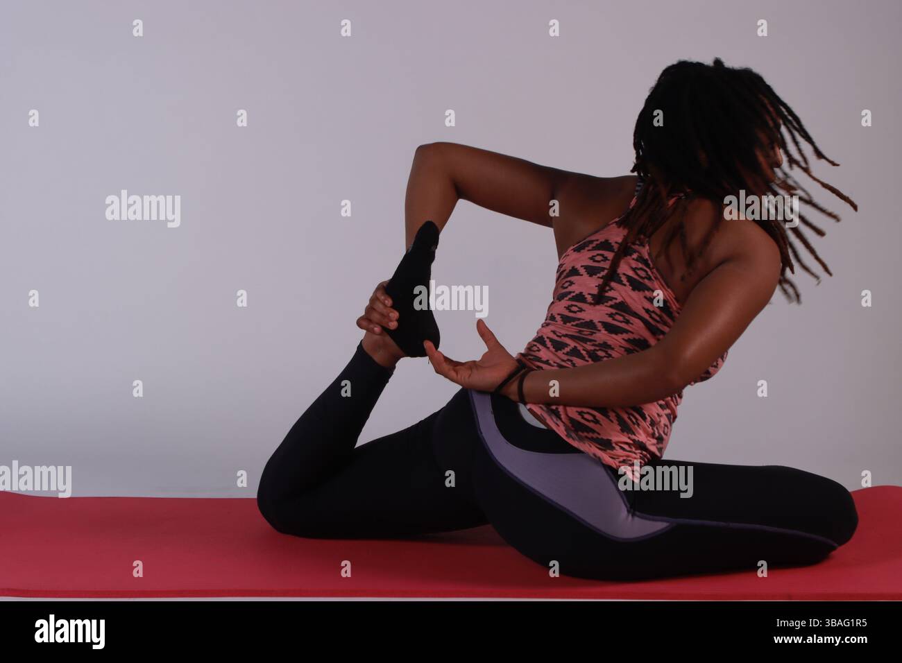 Black Afro-Caribbean woman with natural dreadlocks wearing fitness ...