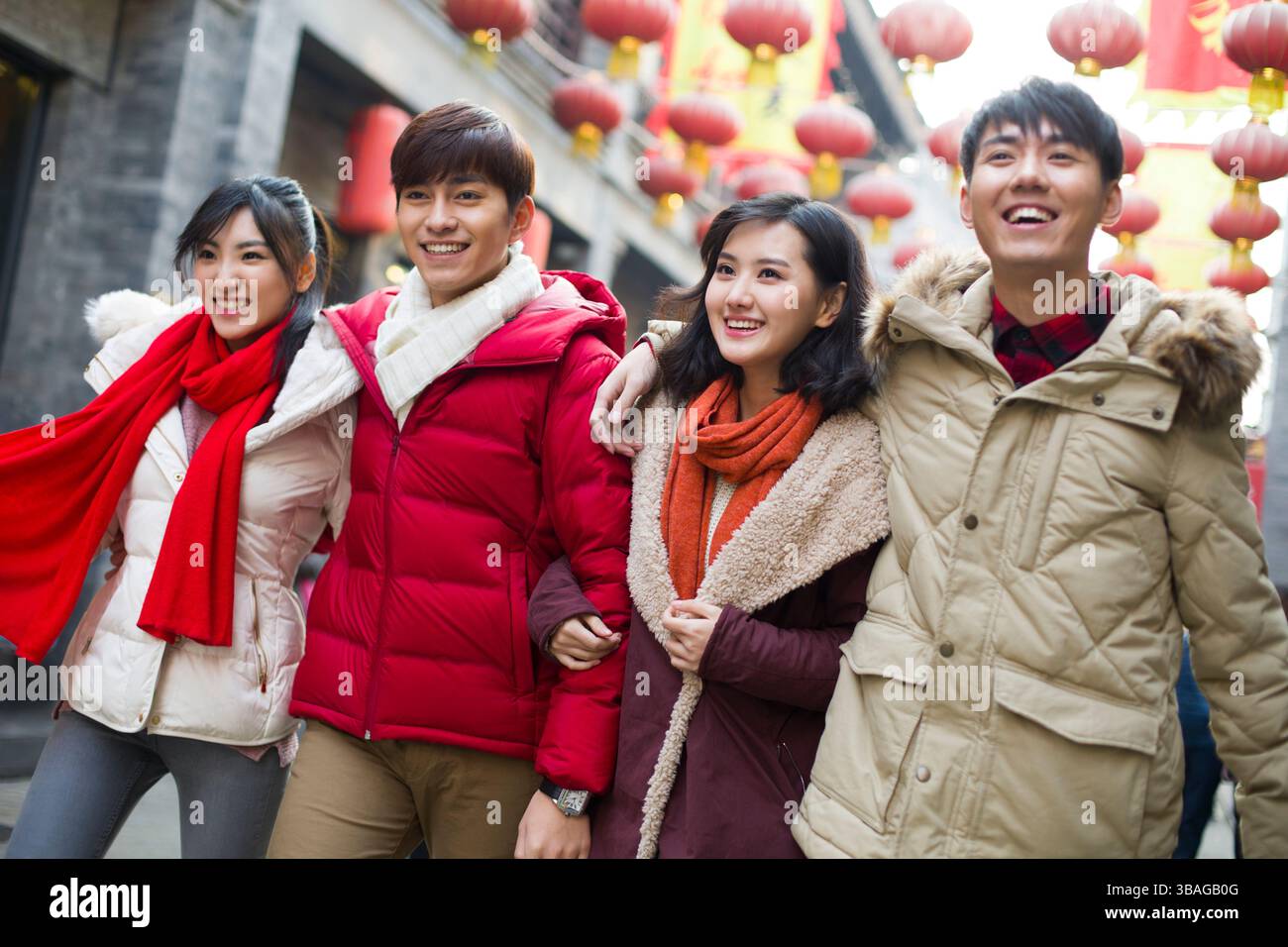 Young Chinese friends walking together on street Stock Photo - Alamy
