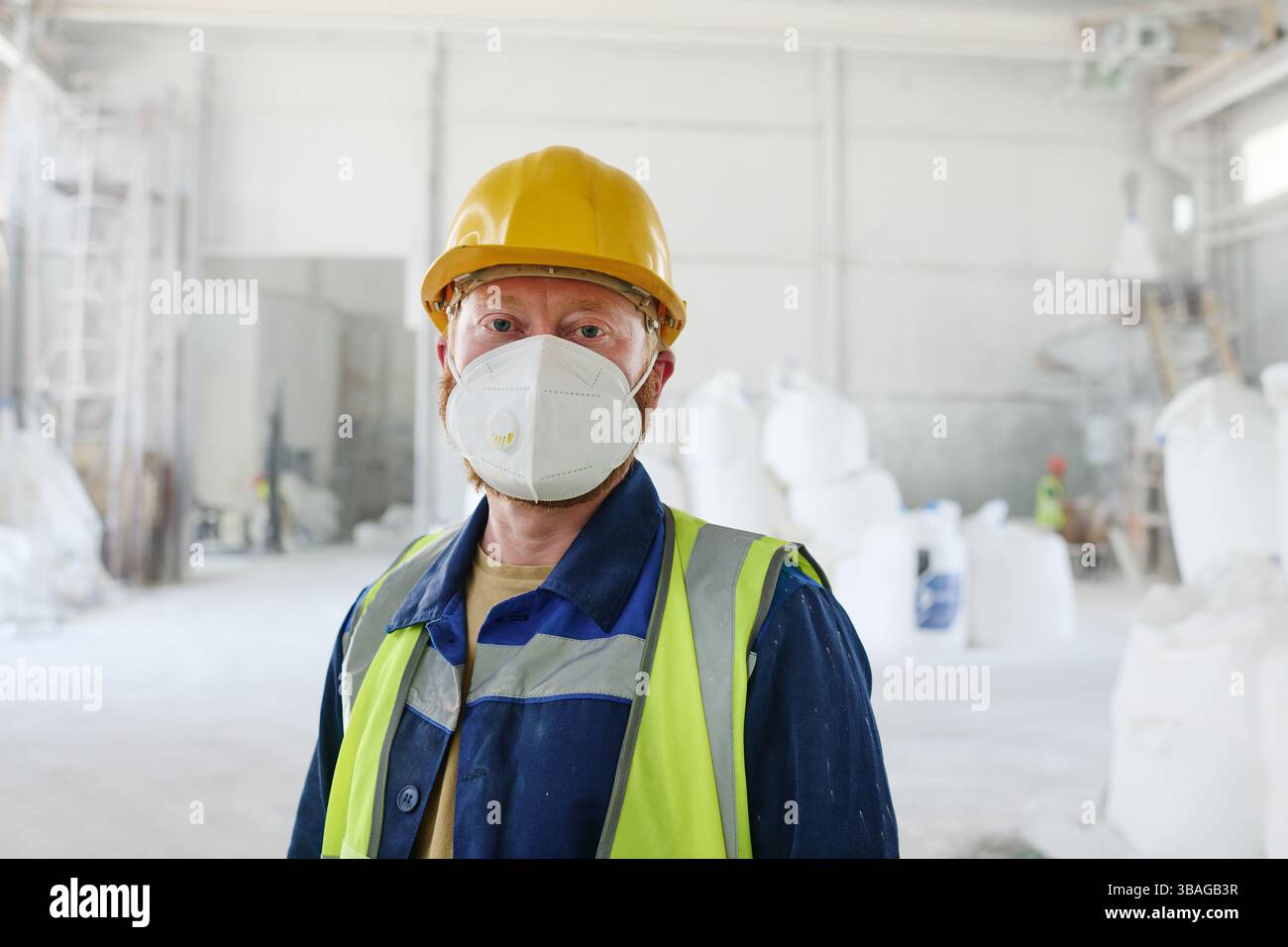 Worker of modern factory or distribution warehouse wearing protective ...