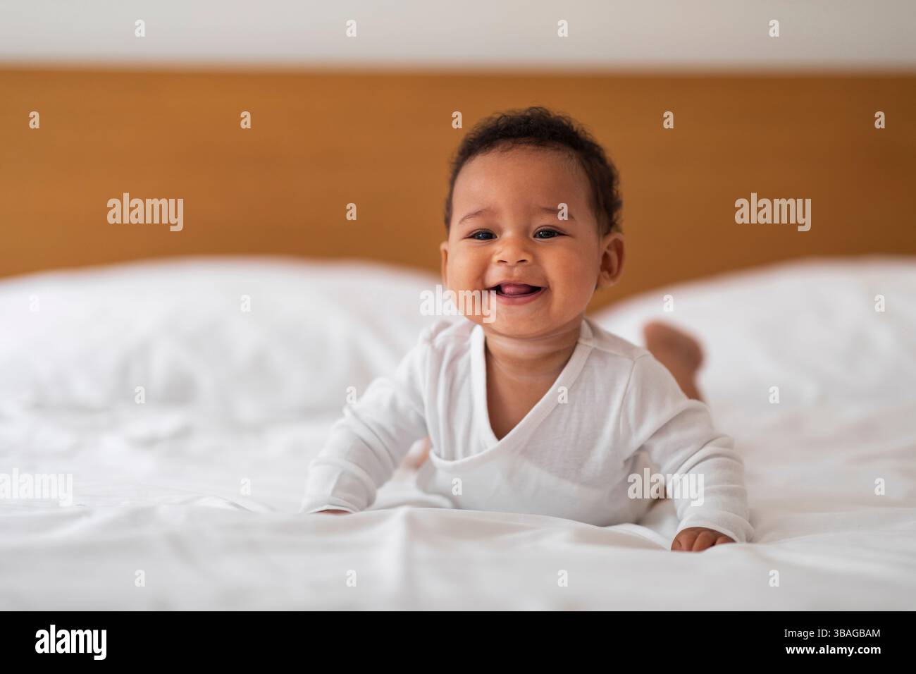 Baby Care Concept. Adorable Black Infant Child Relaxing On Bed At Home ...