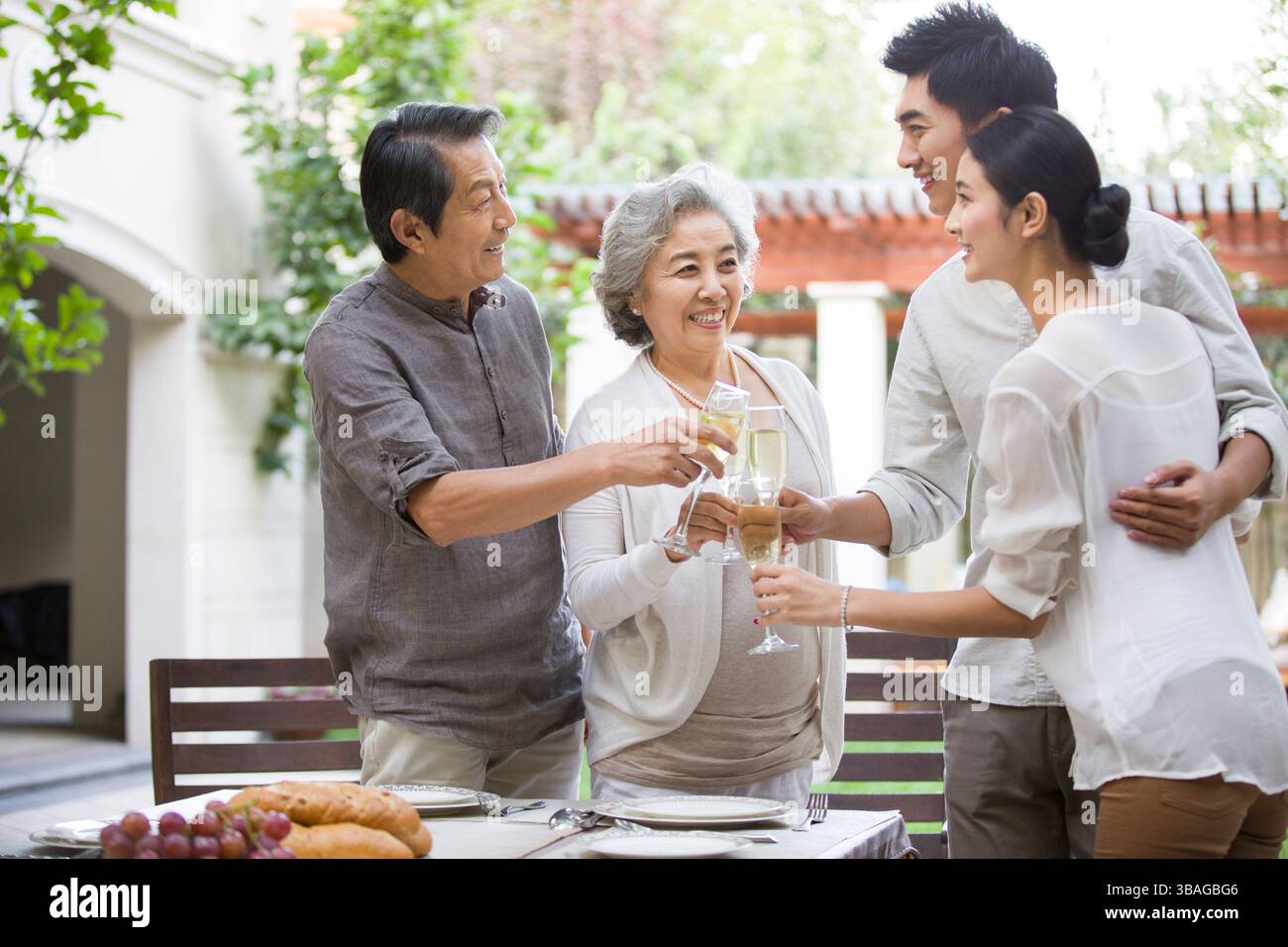 Happy Chinese family celebrating with champagne Stock Photo - Alamy