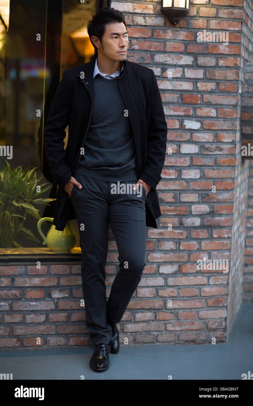 Young Chinese man thinking Stock Photo - Alamy