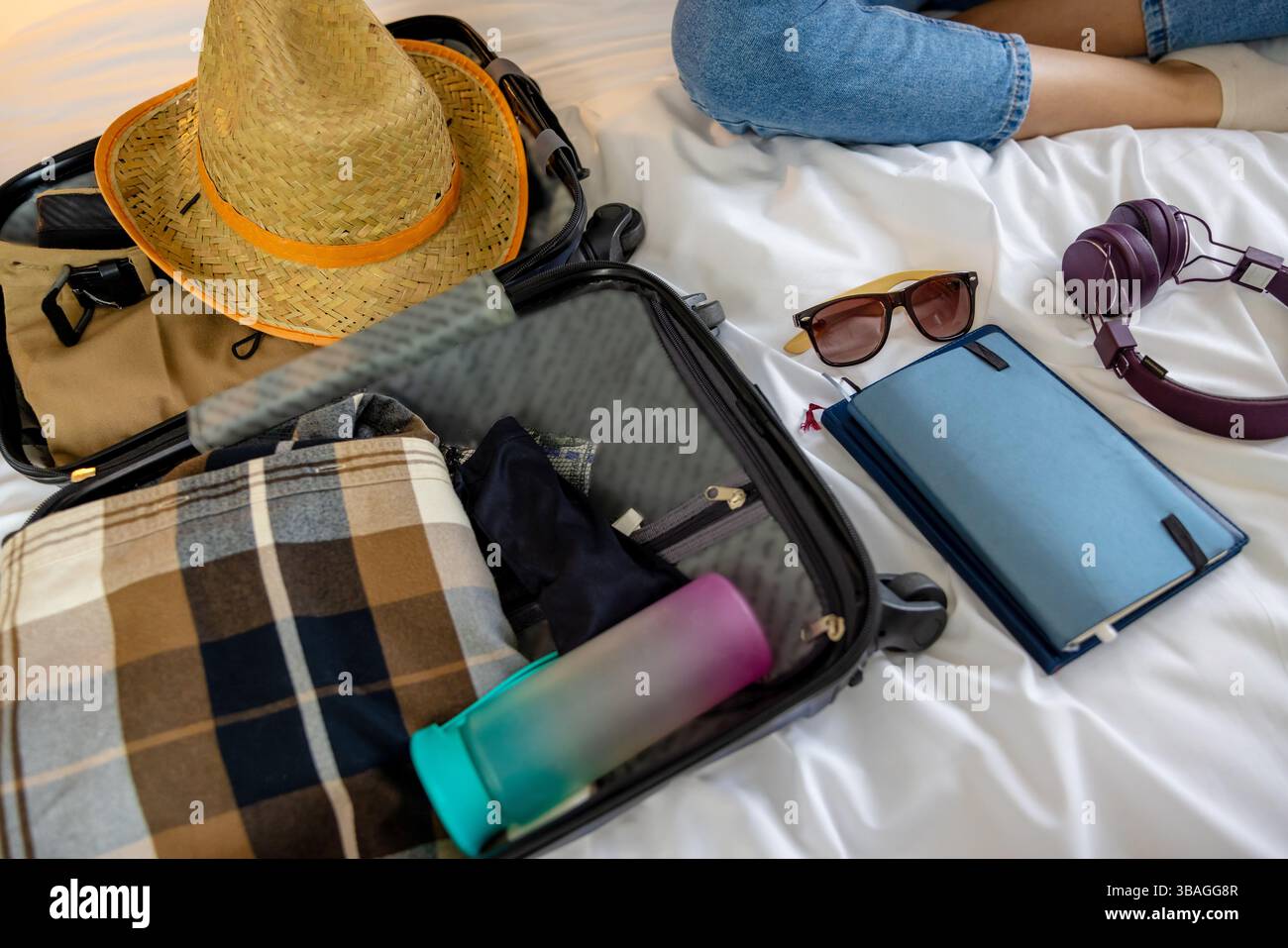 Useful stuff. Close up of clothes and other posessions on the bed Stock ...