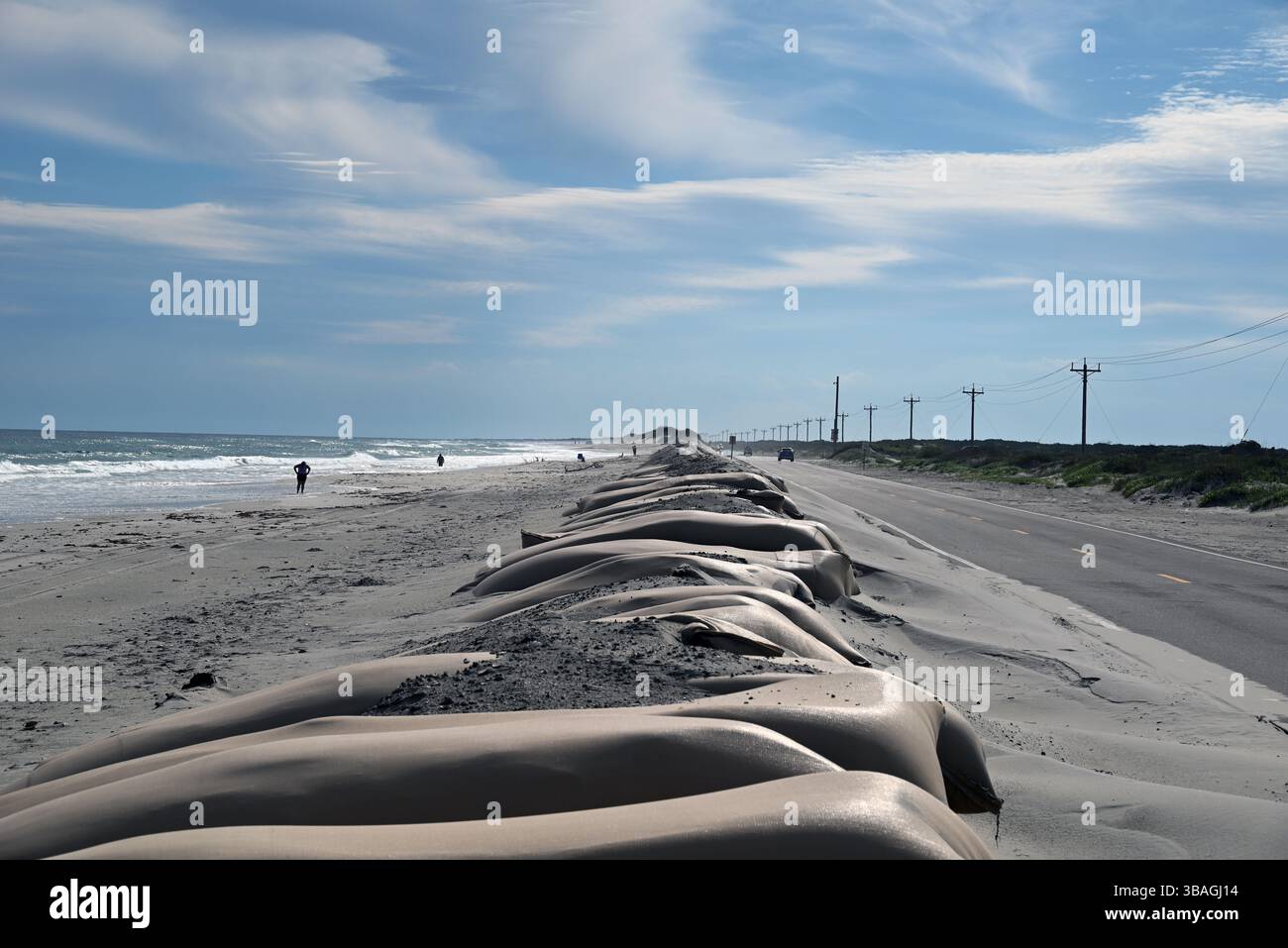 Large sand bags attempt to hold back erosion from the ocean on Route 12 ...