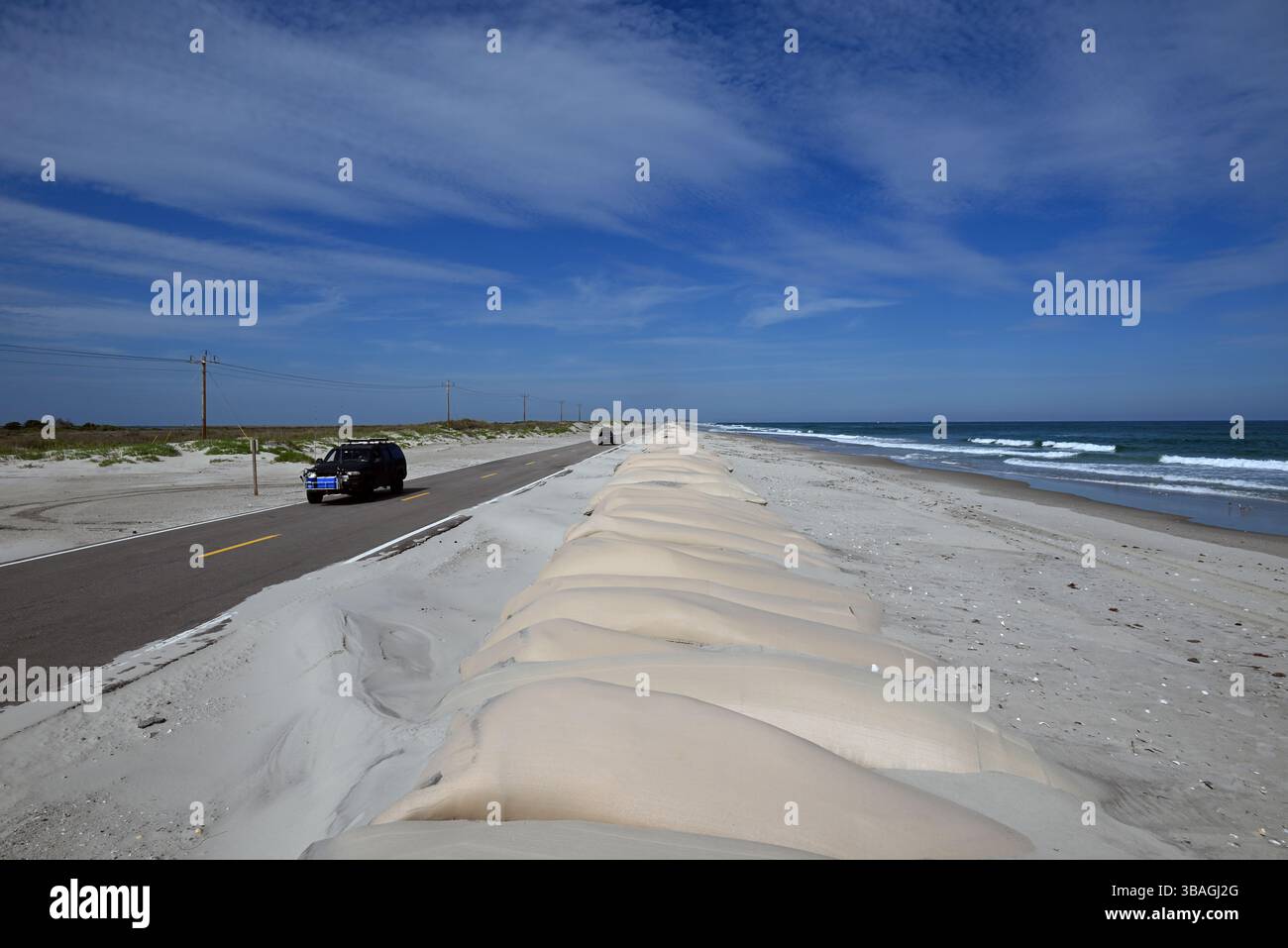 Large sand bags attempt to hold back erosion from the ocean on Route 12 ...