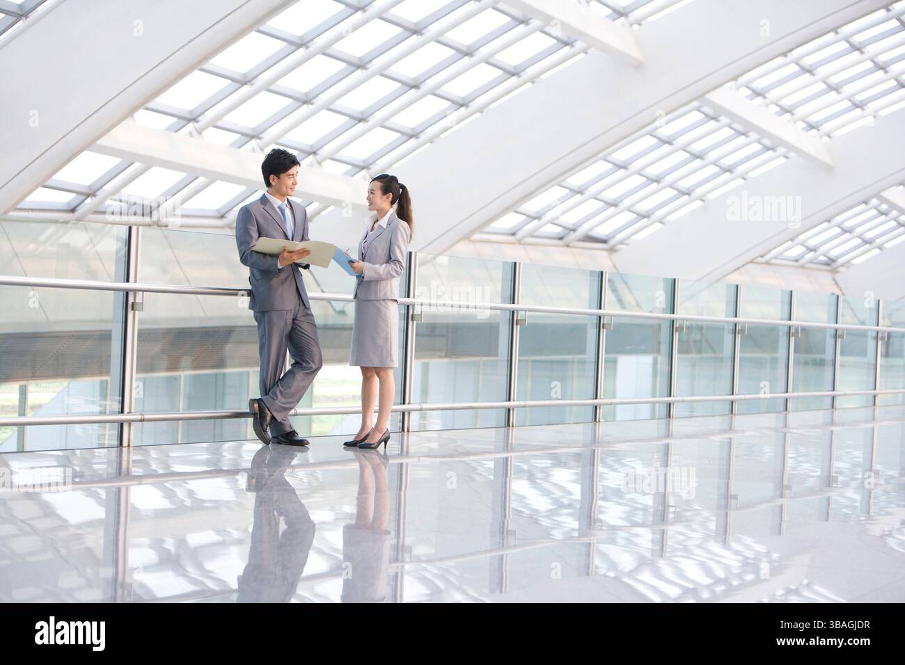 Chinese business partners walking Stock Photo - Alamy