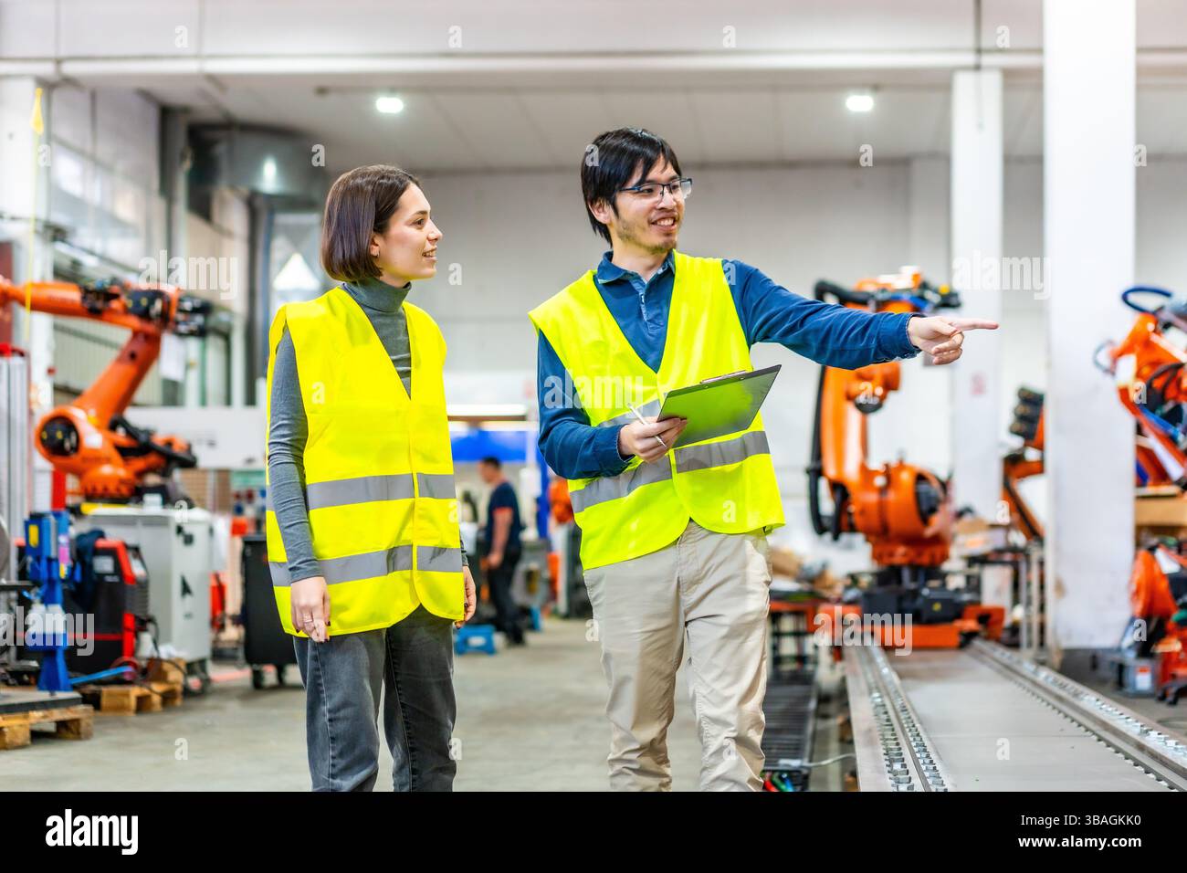 Japanese chief engineer explaining and pointing robotic welding process ...