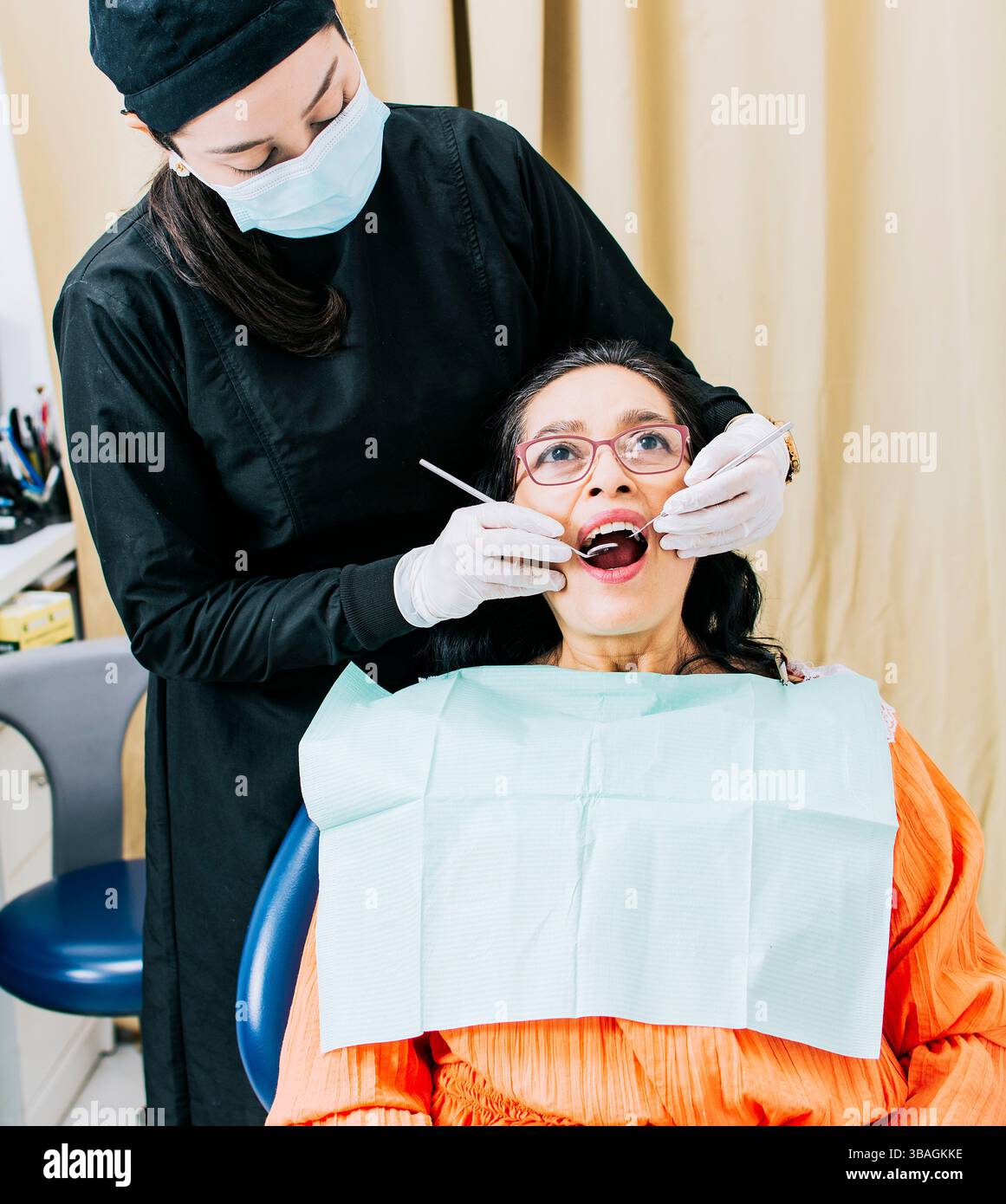 Nicaraguan female dentist wearing face mask and gloves using ...